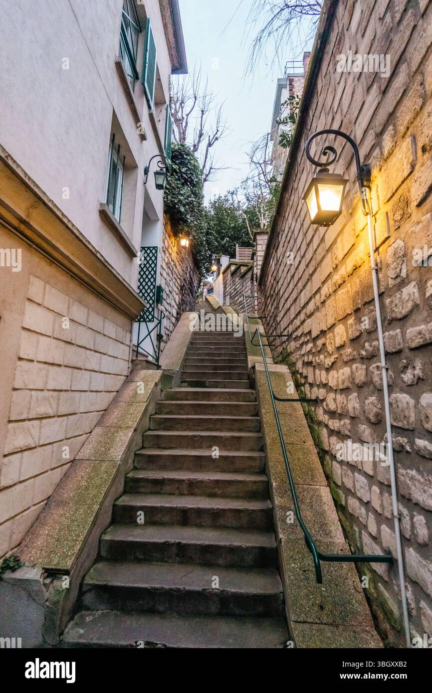 An atmospheric view looking up a narrow stone staircase squeezed ...