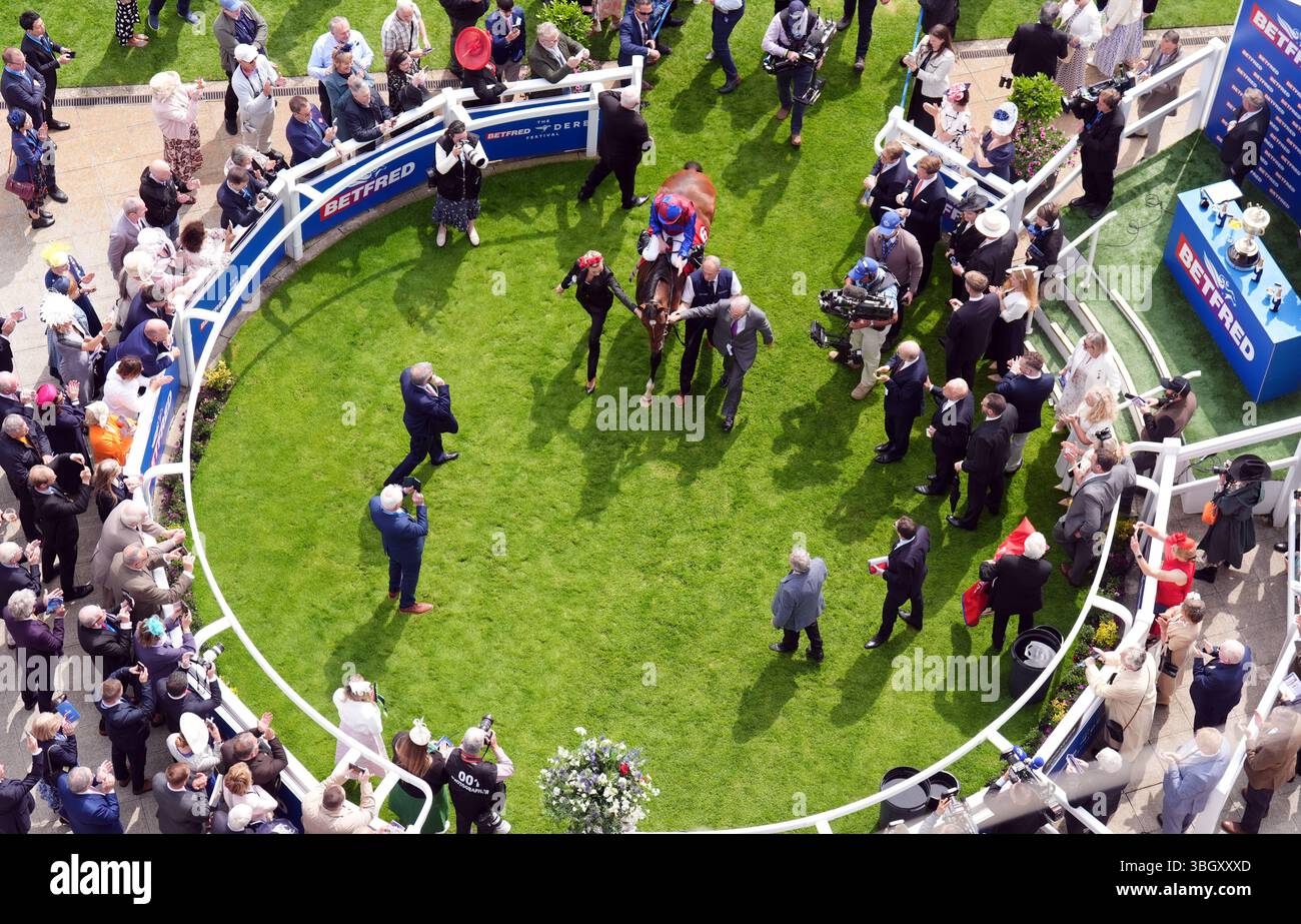 Jan Brueghel ridden by Ryan Moore is led into the winners enclosure ...