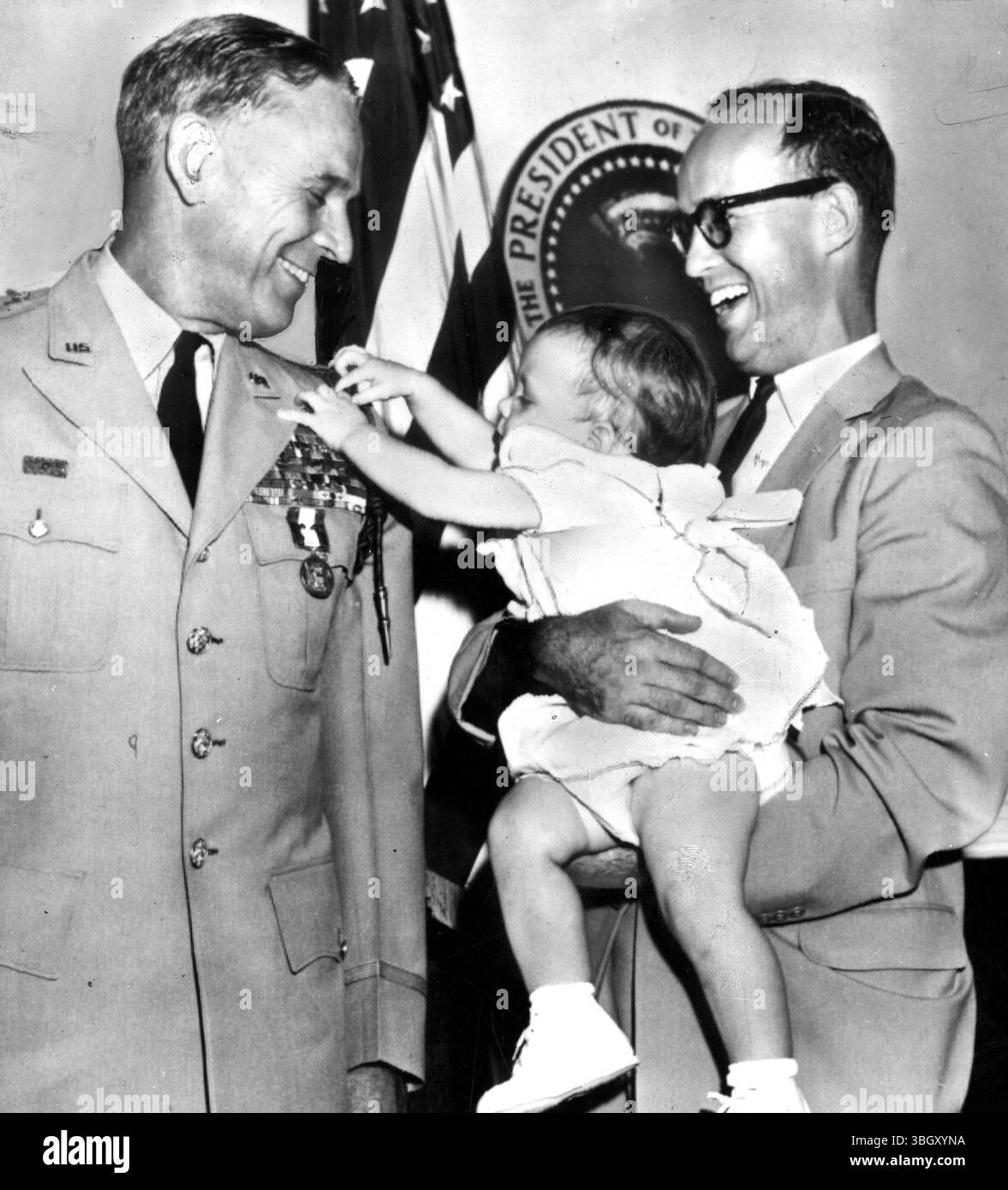 Alice Spaulding Taylor, 15 months, admires the declarations worn by her ...