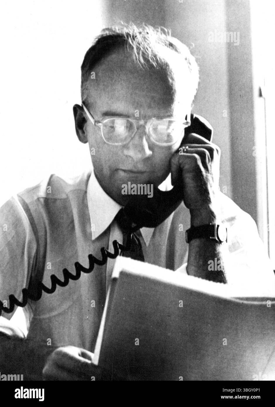 Criminal attorney Charles Symmes, talks on the phone as he reviews the ...
