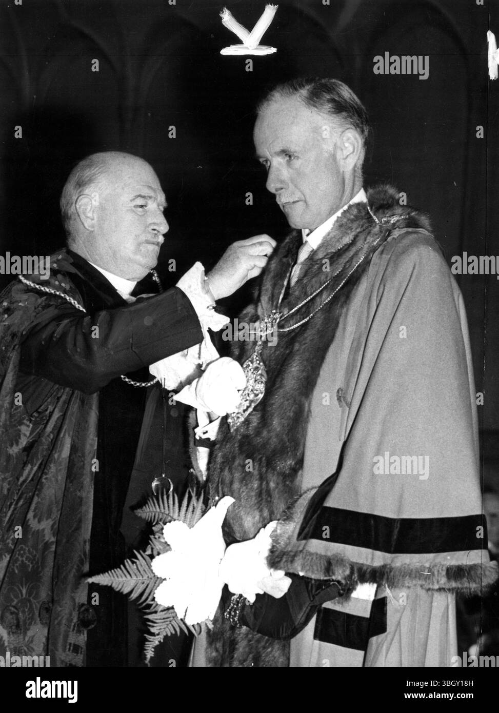 The chain of office (as Lord Mayor) is placed around the neck of ...