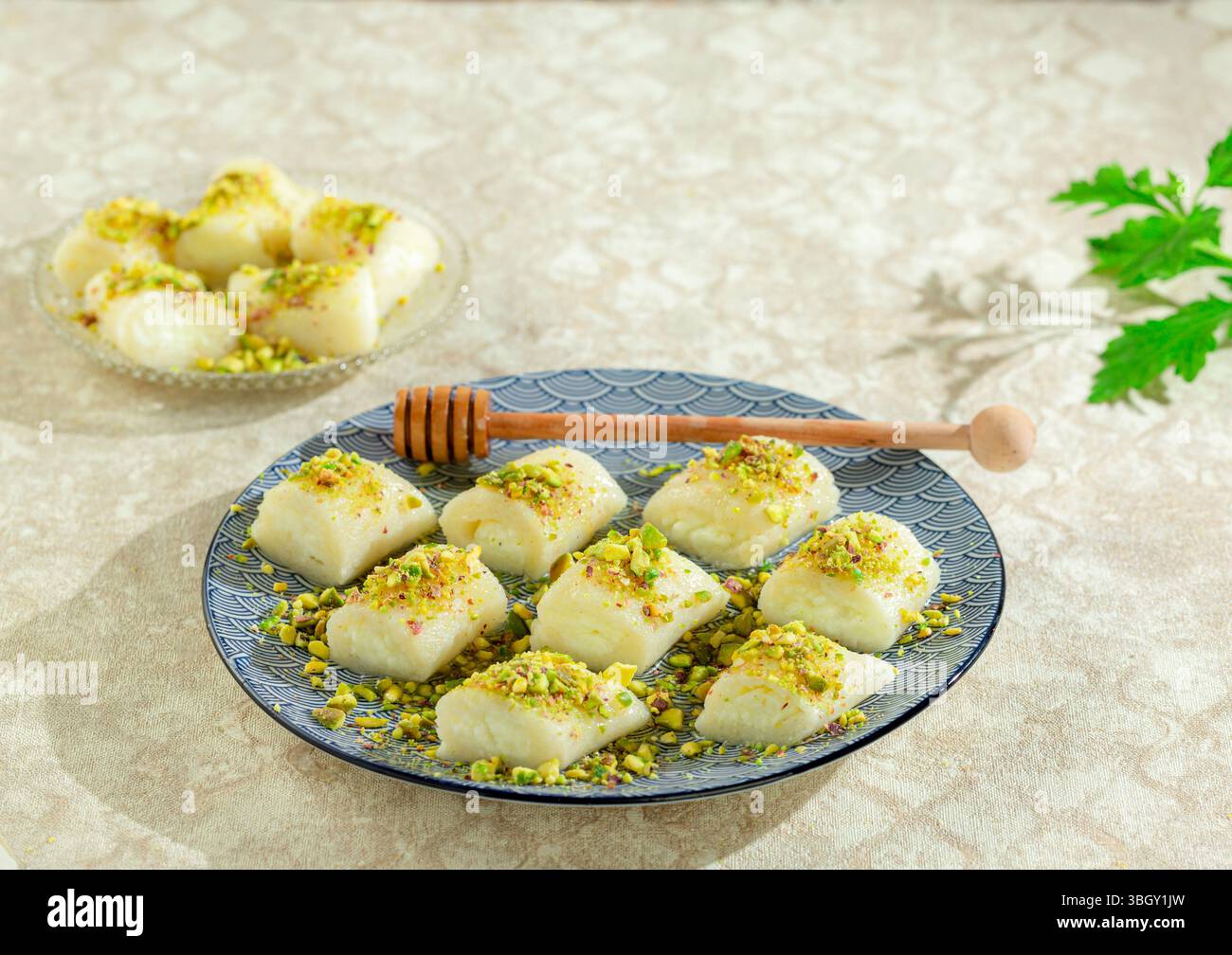 Syrian Arabic dessert, halawet el-jibn with honey Stock Photo - Alamy
