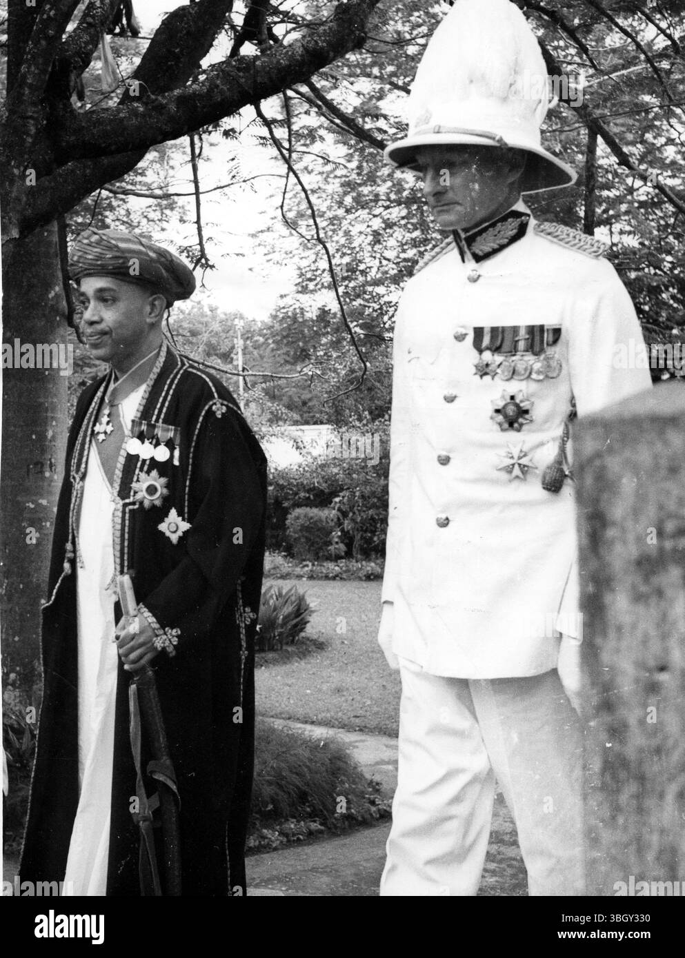 His Highness the Sultan of Zanzibar Sir Khalifa bin Harub (left) walks ...
