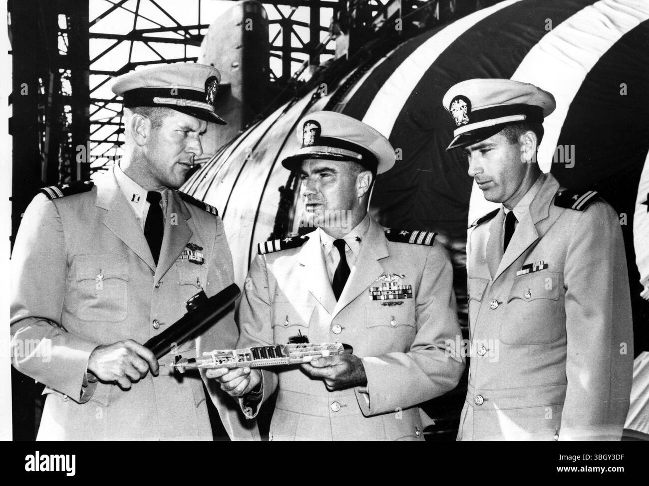 Commander Harold B. Sear (centre), captain of the ballistic missile ...
