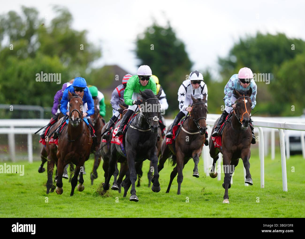 Runners and riders in the Betfred British EBF Woodcote Stakes during ...