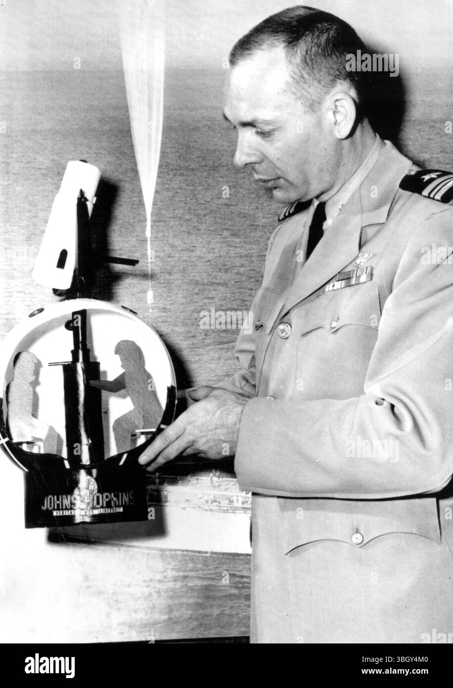 Navy Commander Malcolm D Ross examines a cutaway model of the Strato ...