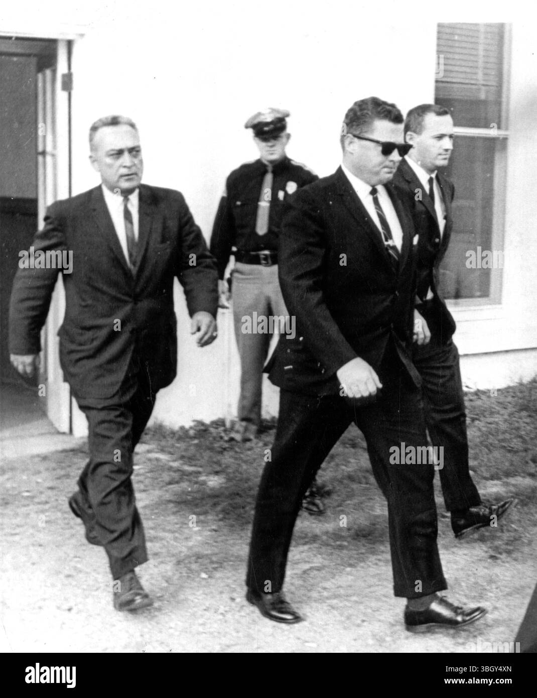 Gary Thomas Rowe (wearing glasses) is flanked by FBI agents as he ...