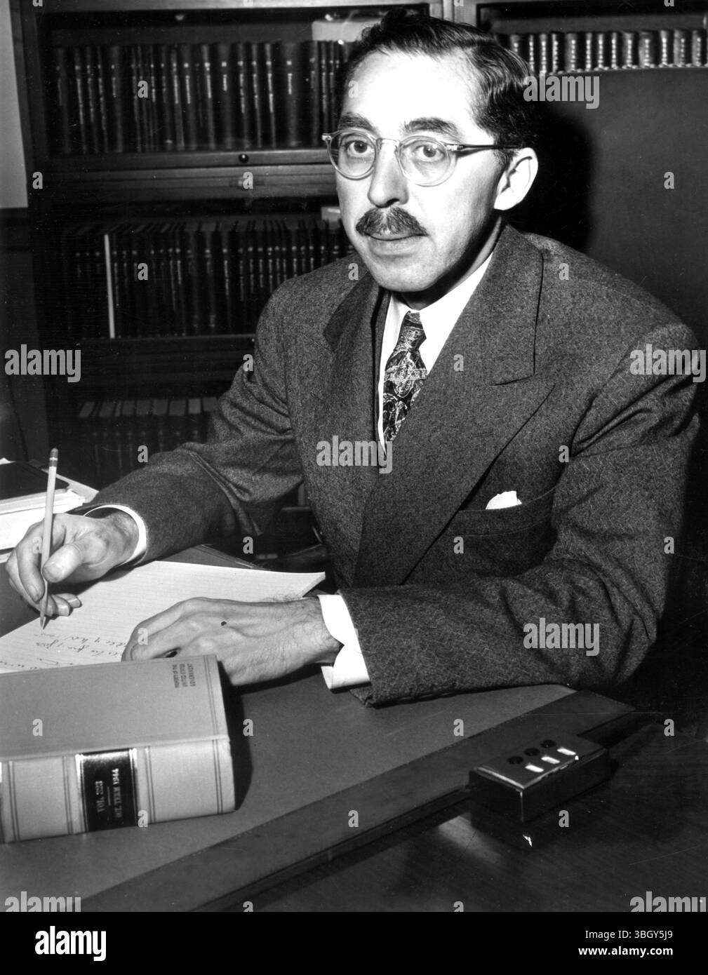 Simon H Rifkind, Judge of the Federal Court, shown seated at his desk ...