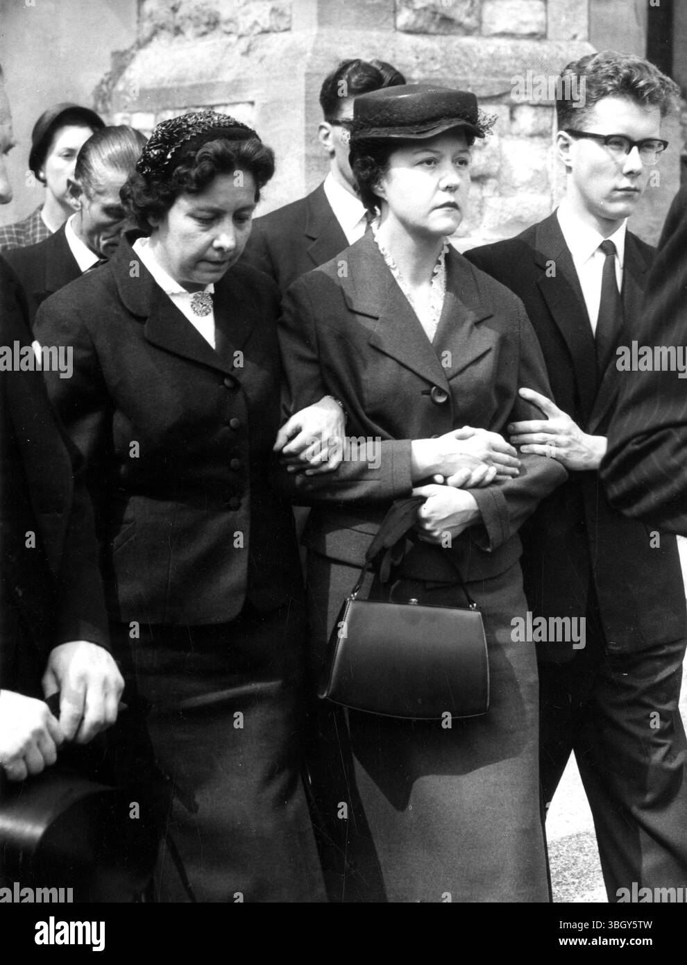 Irene Purdy and her son, Alan, before the coffin of her husband ...