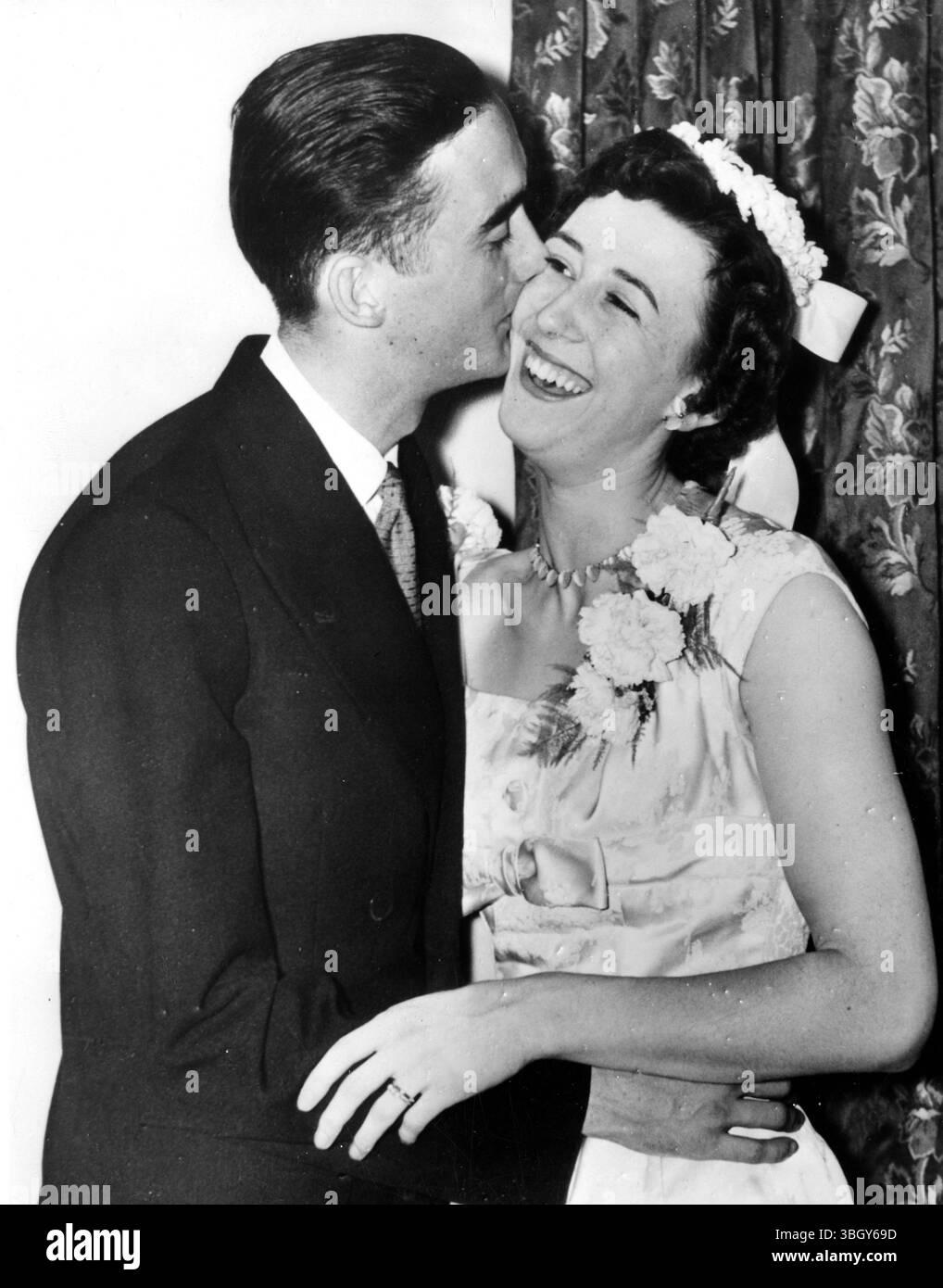 Athletic kiss. Long-distance runner Gordon Pirie, kisses his bride ...