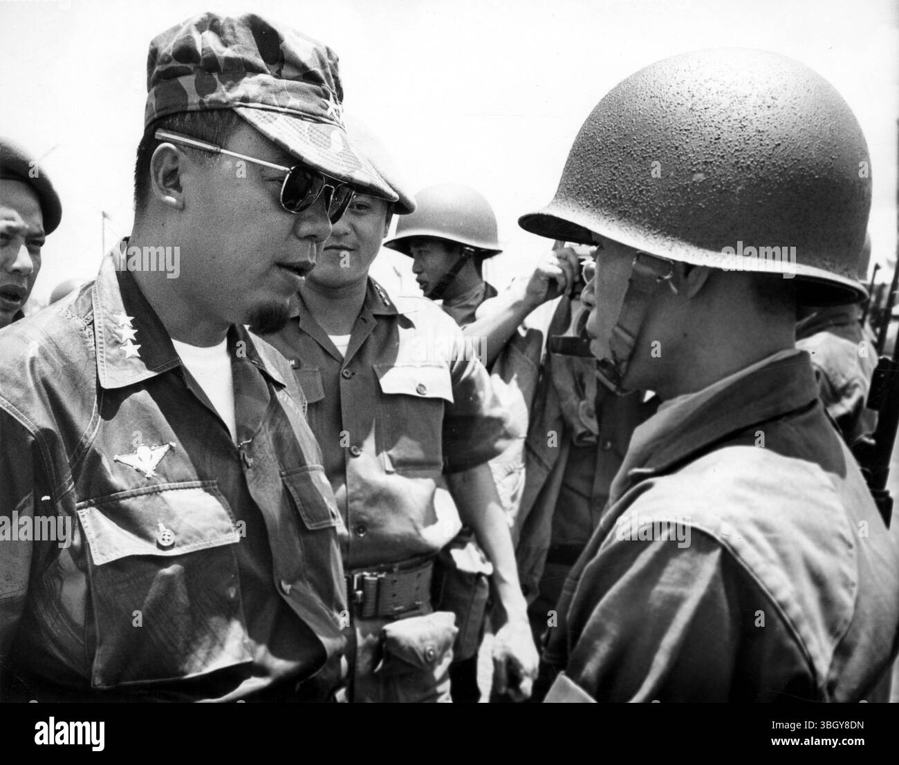 South Vietnam's Premier, general Nguyen Khanh, talks to a helmeted ...