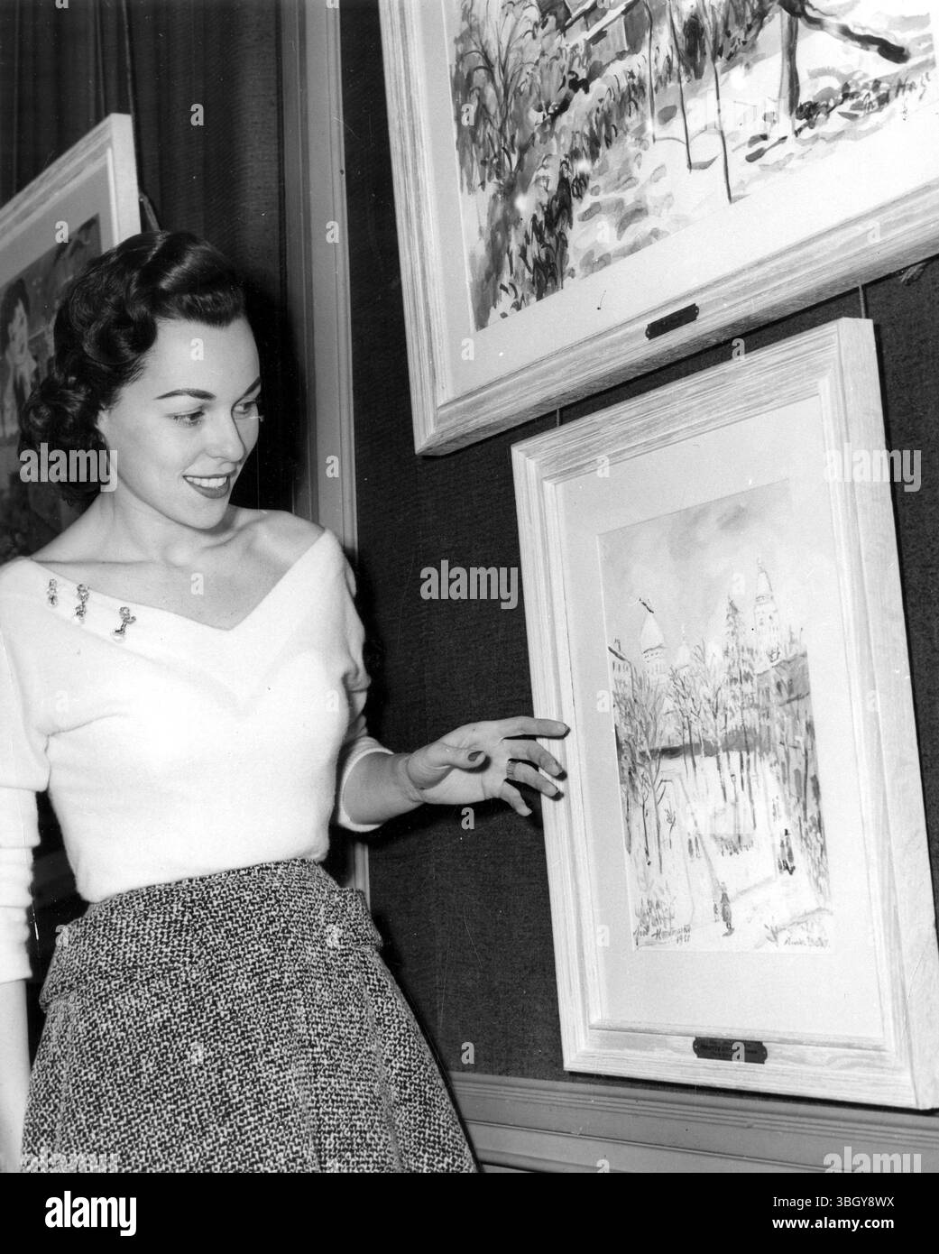 Bess Myerson, TV star and former Miss America, admires a painting believed to be the last work ...