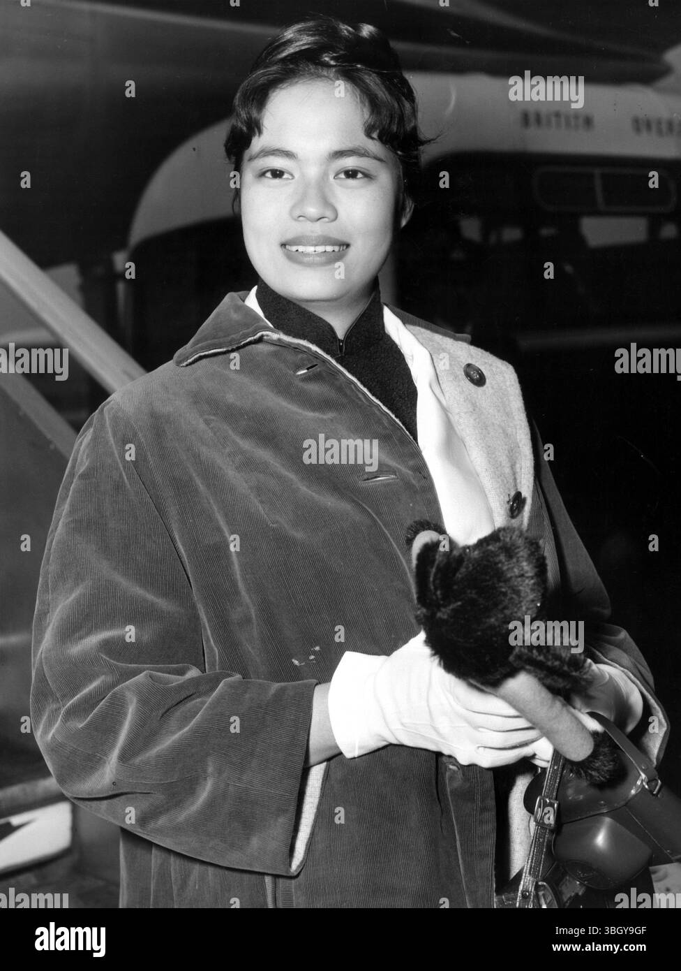 Michelle Mok "Miss Hong Kong", carries her doll mascot as she arrives ...