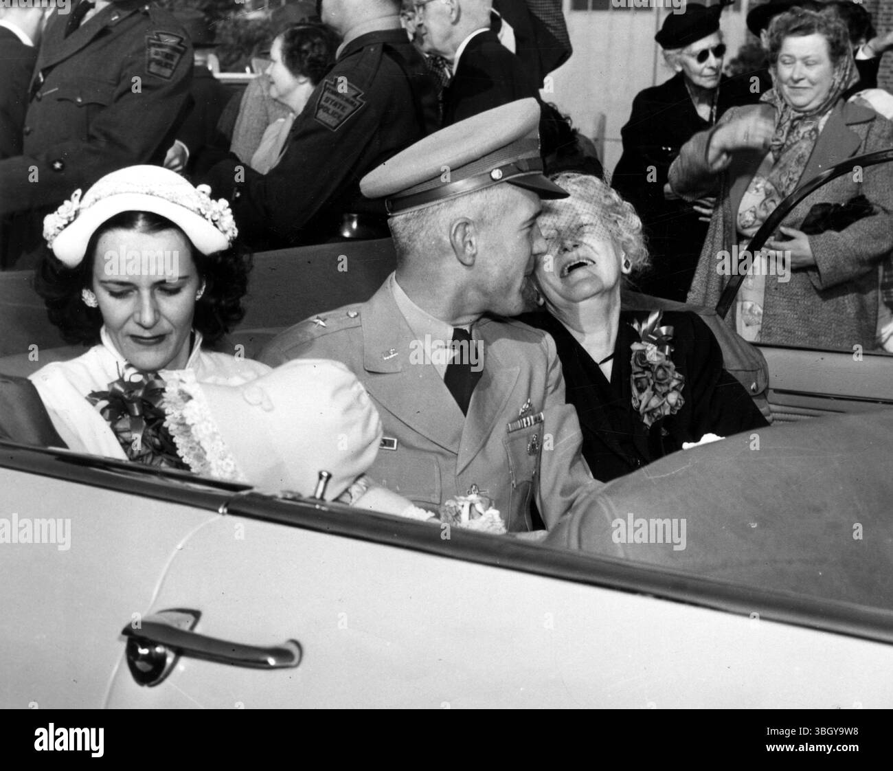 Home again. While state police keep the crowds away from his car ...