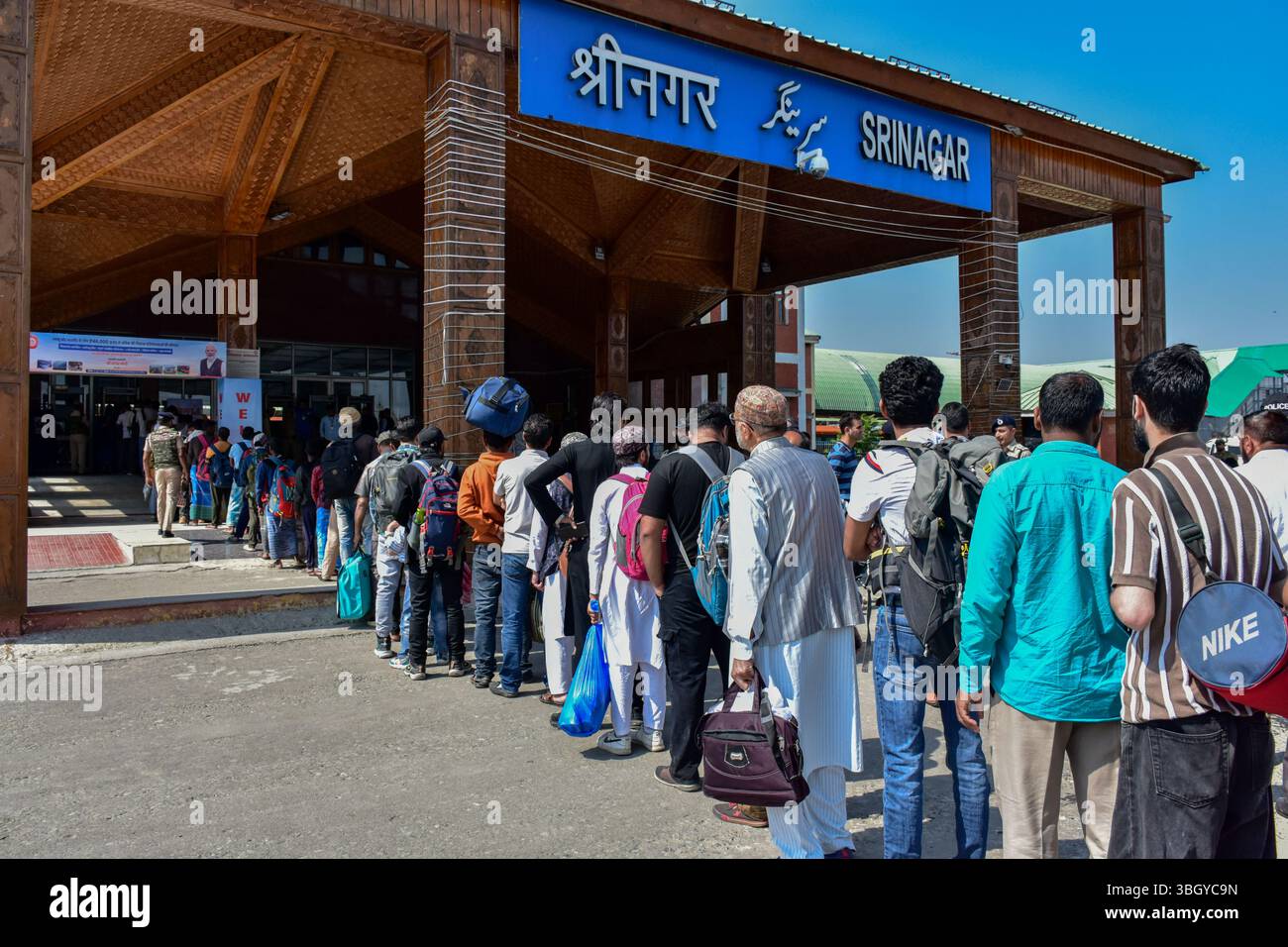 Srinagar, India. 06th June, 2025. People stand in a queue as they wait ...