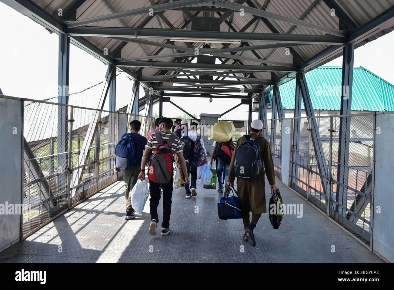 Srinagar, India. 06th June, 2025. People walk to board a train at the ...