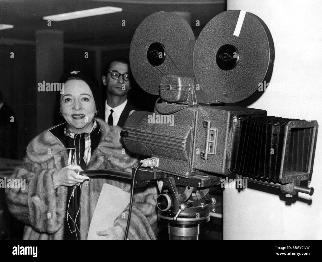 American actress, Jessie Royce Landis stands behind a film camera. 23 ...