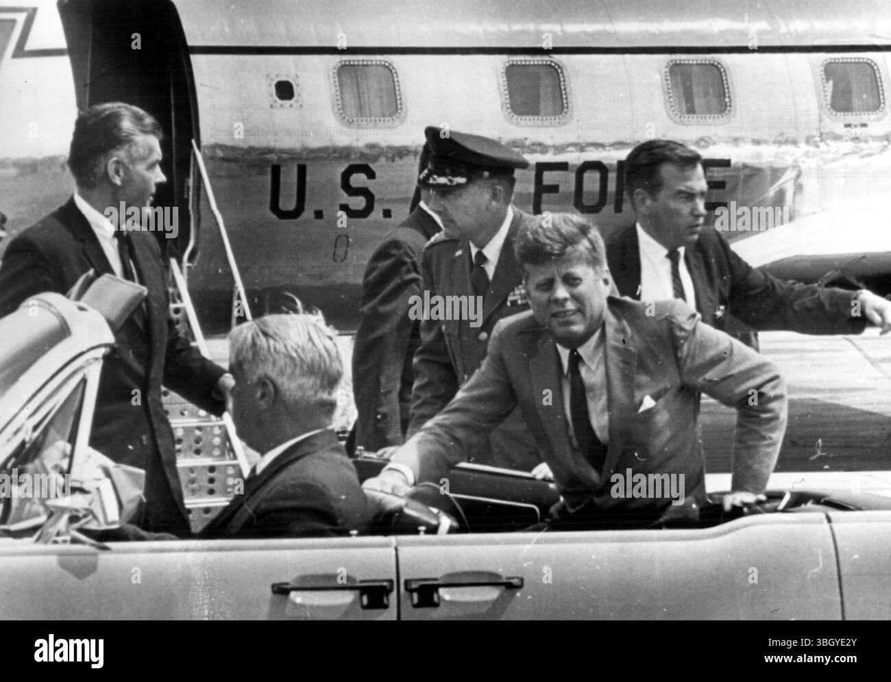 President John Fitzgerald Kennedy rushes to a waiting car after leaving ...