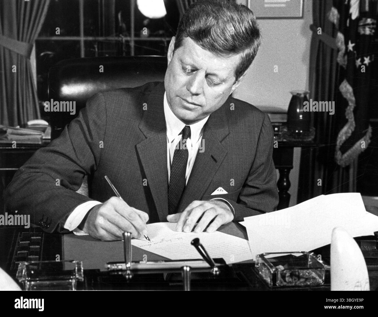 President John Fitzgerald Kennedy signs proclamation formally putting ...