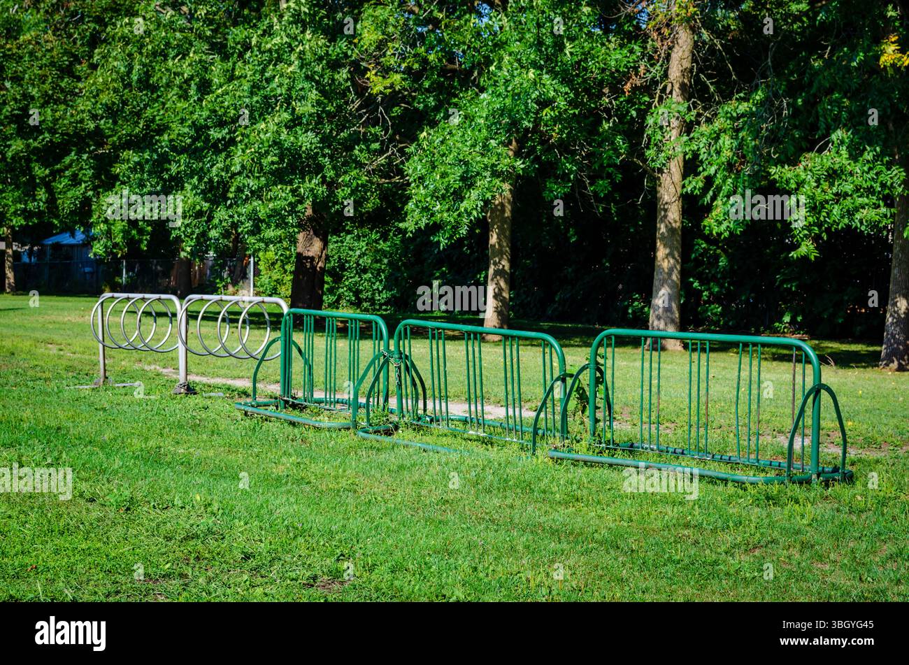 Empty bicycle racks in a park next to a path Stock Photo - Alamy