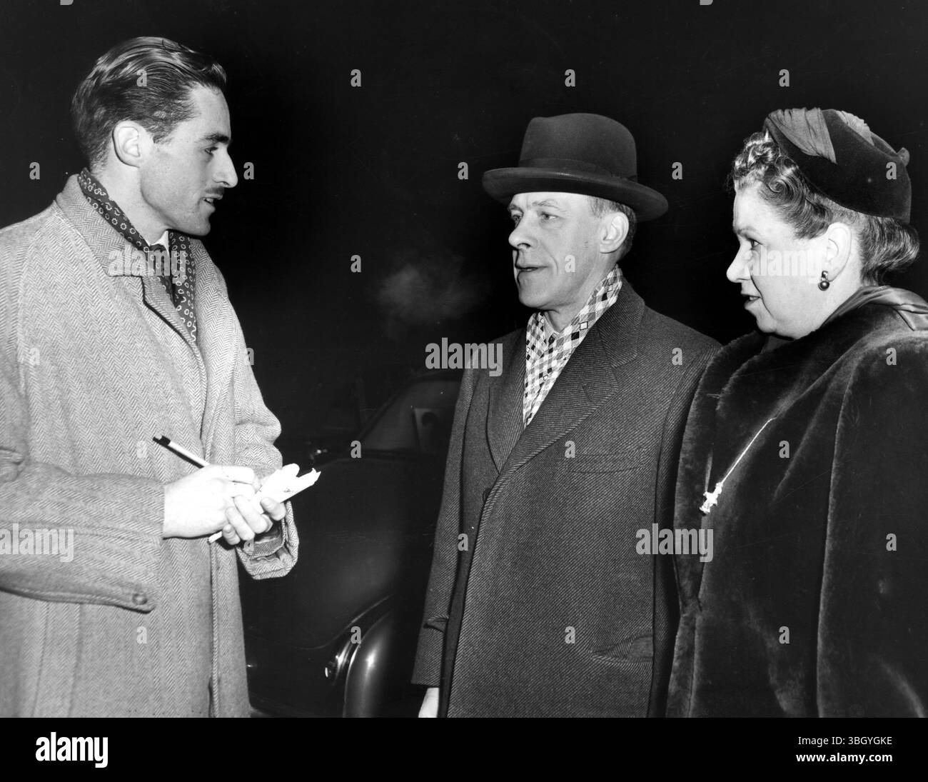 Donald R Heath (centre) with his wife, is interviewed by Paris United ...