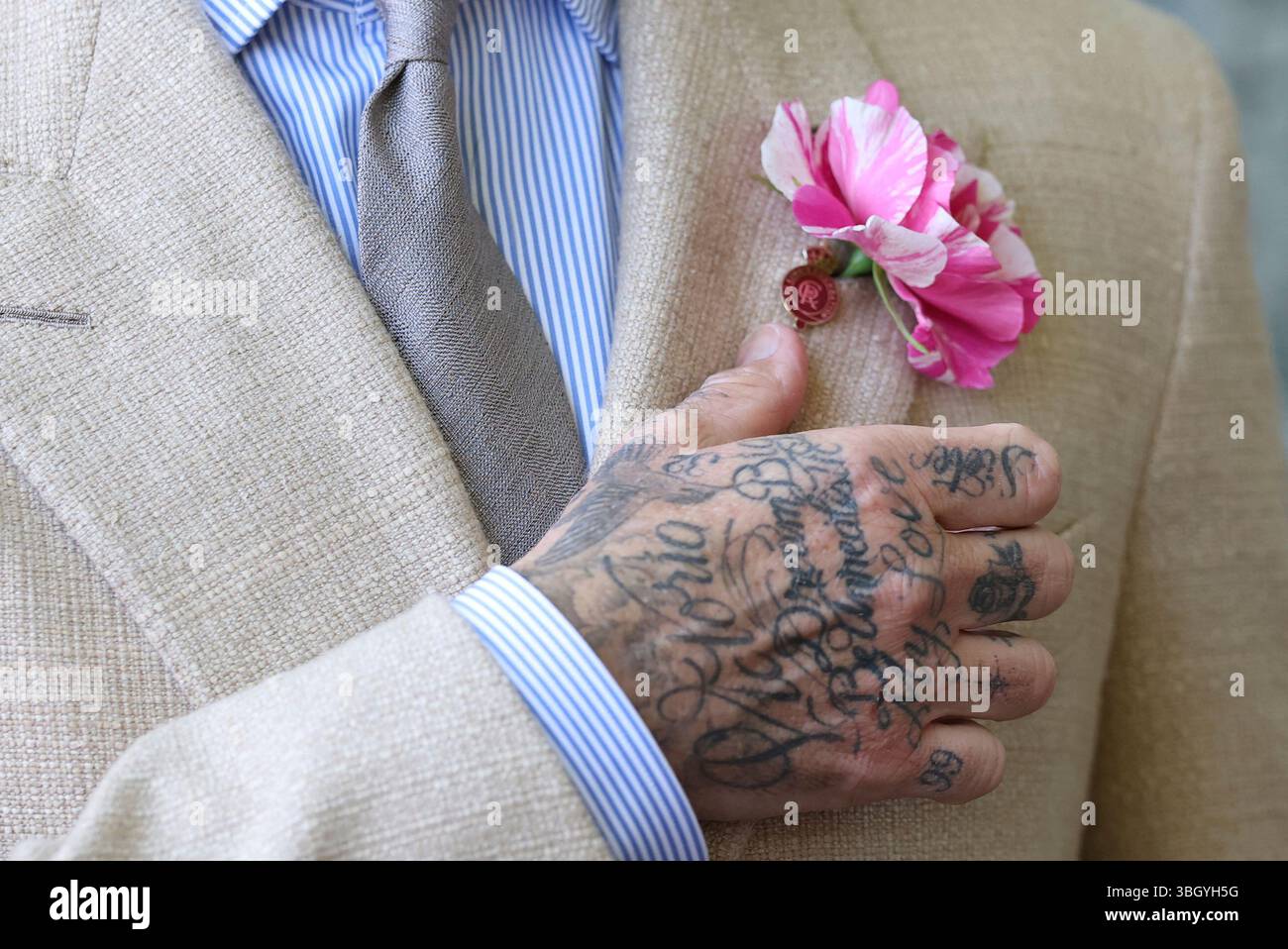Former soccer player David Beckham adjusts a "King's Rose" by David ...
