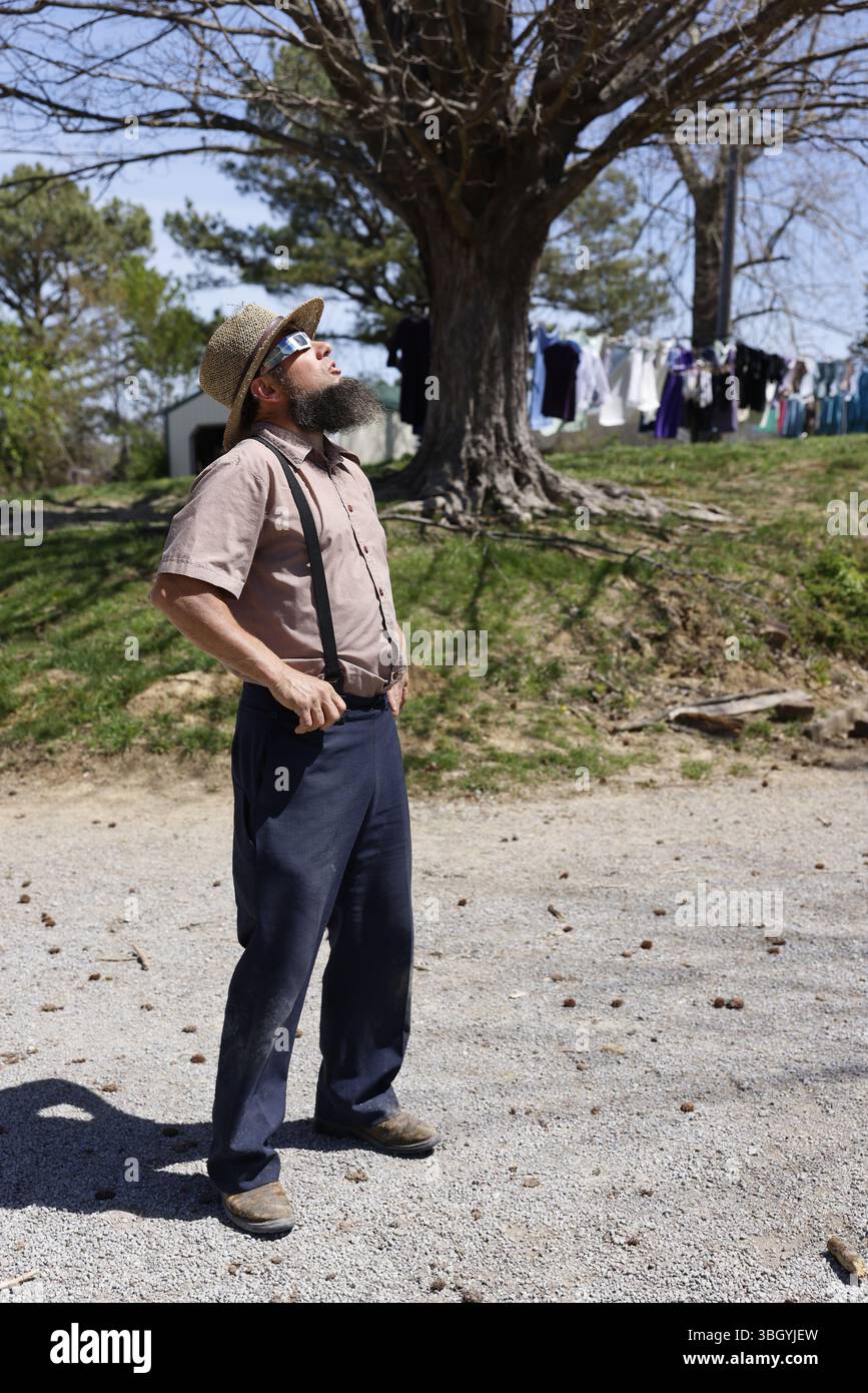 Amish man watches a total solar eclipse Stock Photo - Alamy