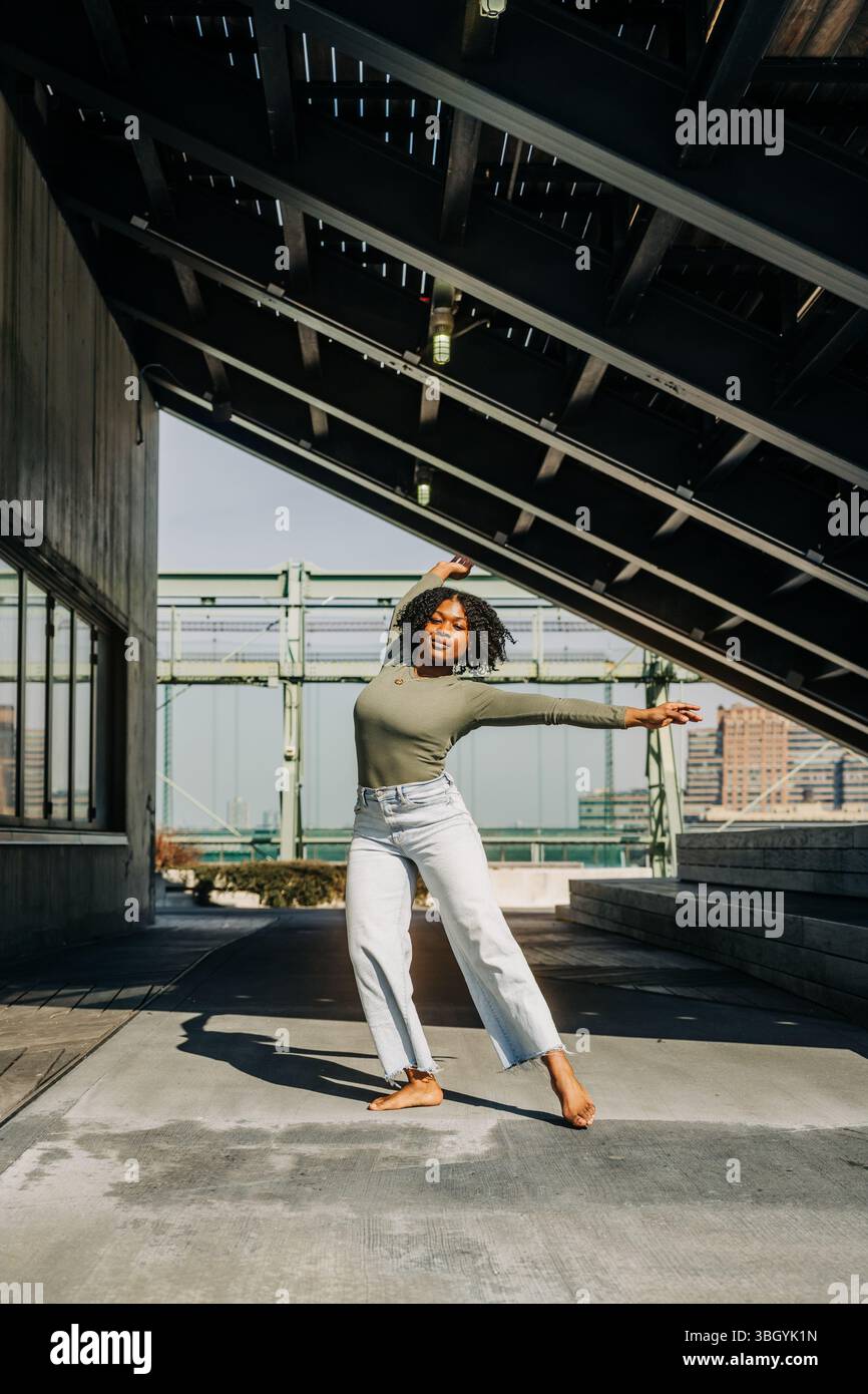 Dancer poses gracefully under angular architectural ceiling Stock Photo ...