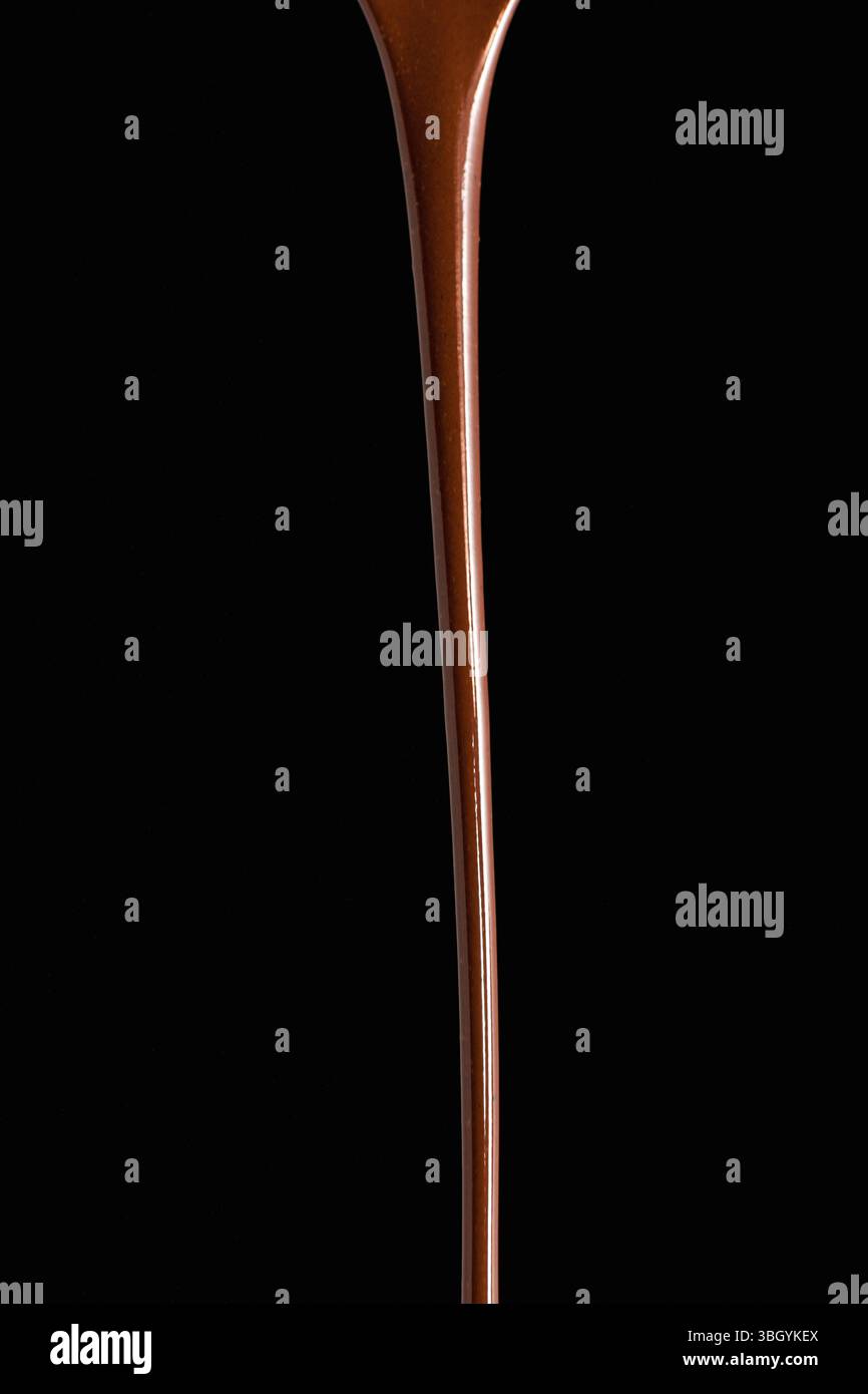 Pouring stream of milk chocolate Stock Photo - Alamy