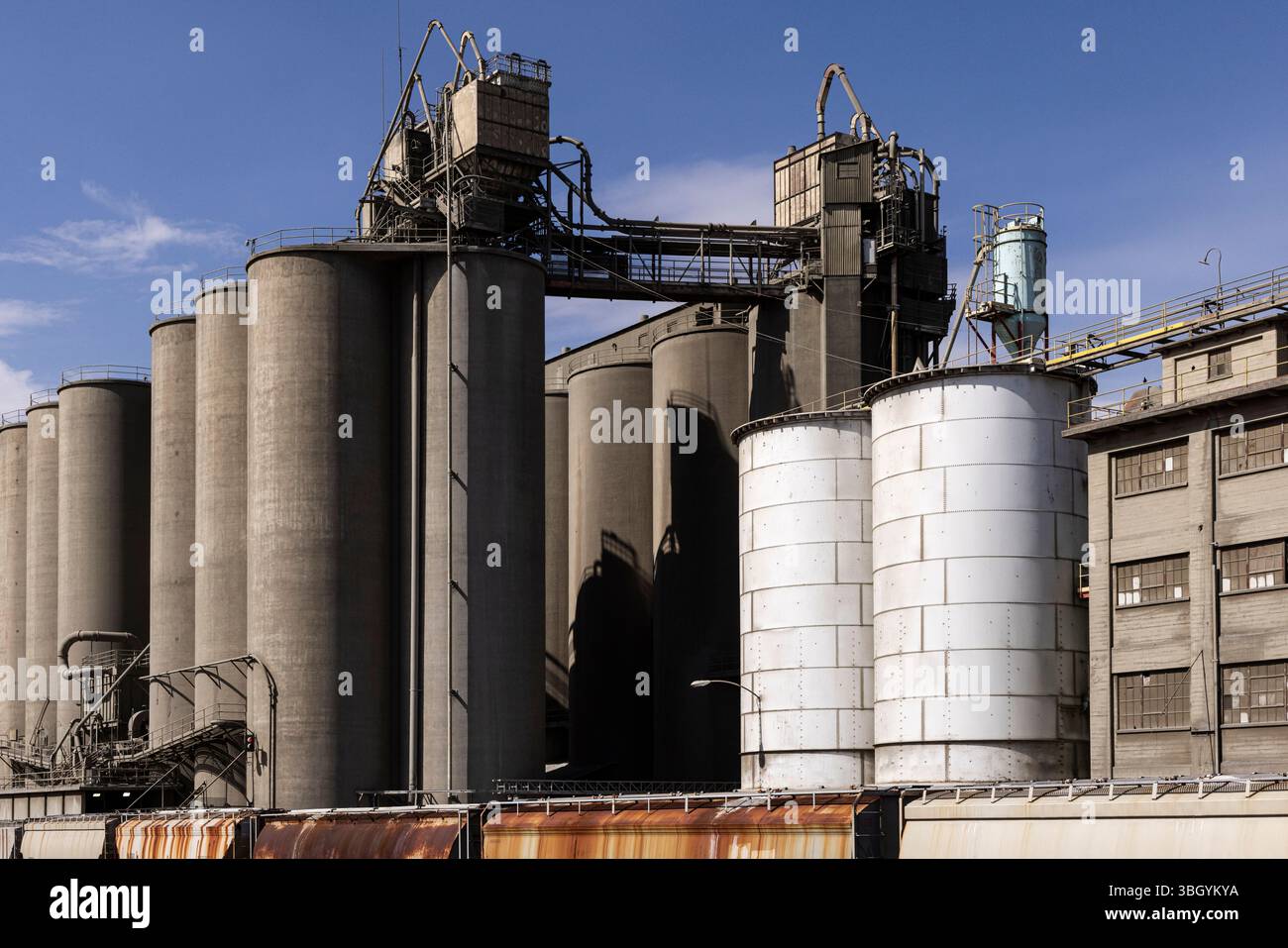 Industrial landscape concrete silos by train tracks Stock Photo - Alamy