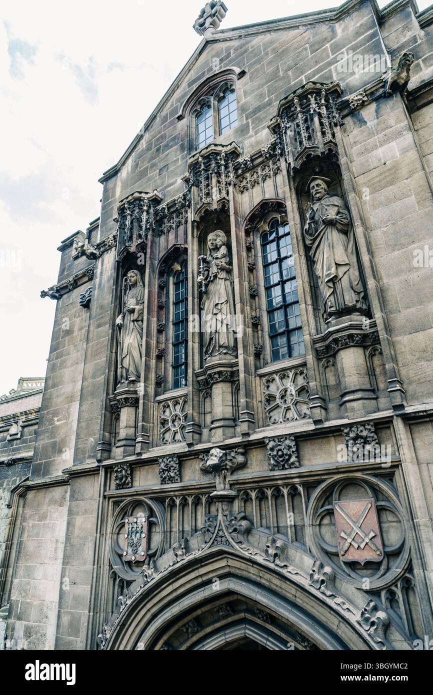 Gothic church facade with stone statues and arched windows Stock Photo ...