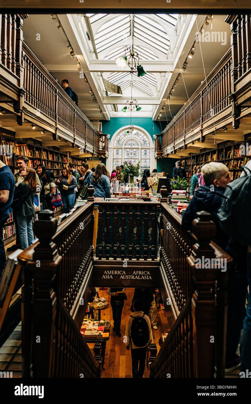 Crowded two-story bookstore with wooden interior and skylight Stock ...