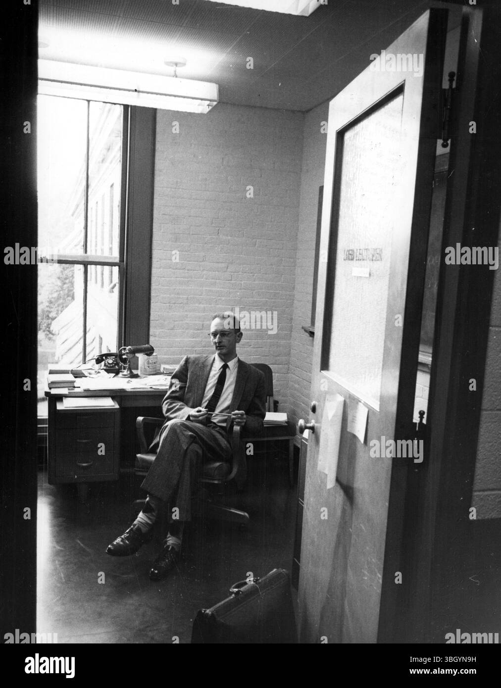 Atomic scientist Dr Owen Chamberlain sits in the cubicle he uses as an ...
