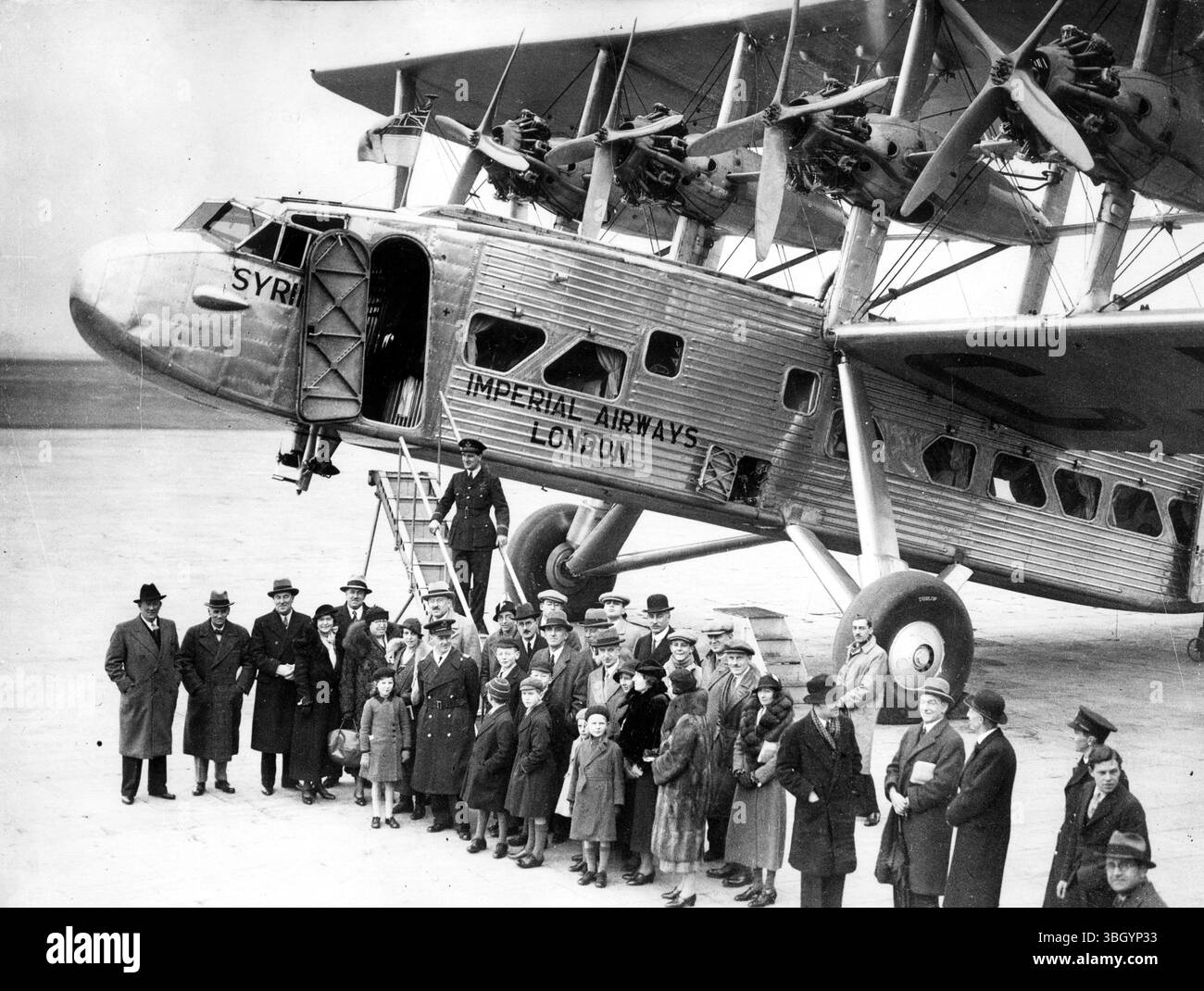 Passengers line up before departure alongside the largest land plane ...