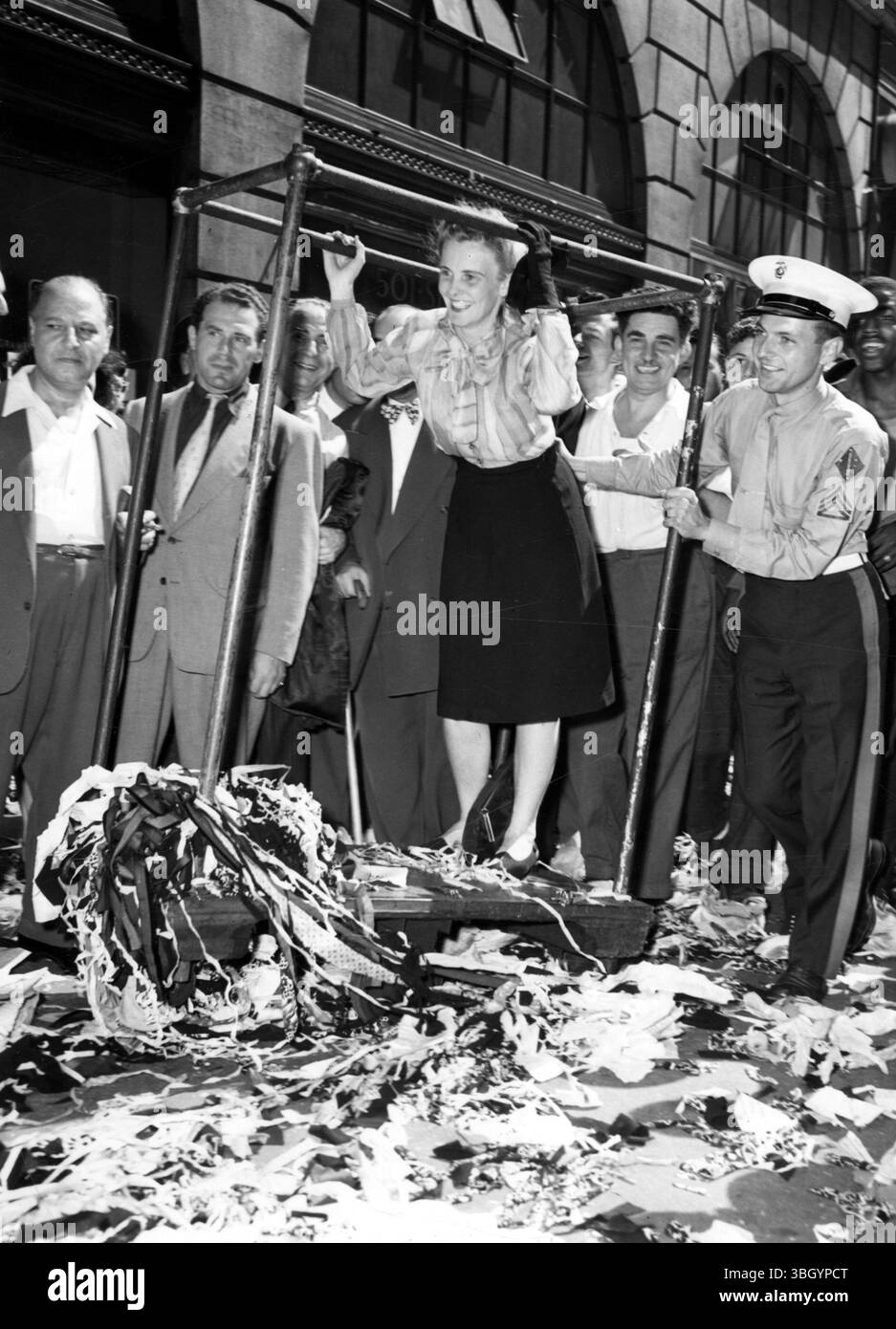 Virginia Halla gets a ride on a garment company ' s hand truck as Staff ...
