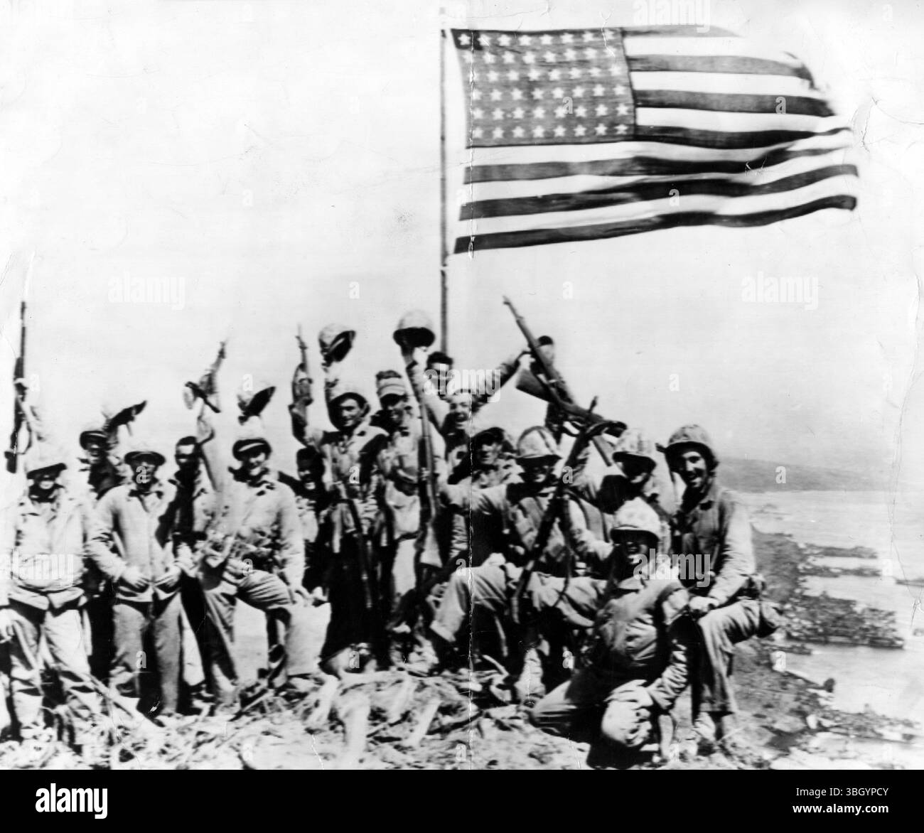 US Marines atop Mount Suribachi , Iwo Jima celebrate raising the ...