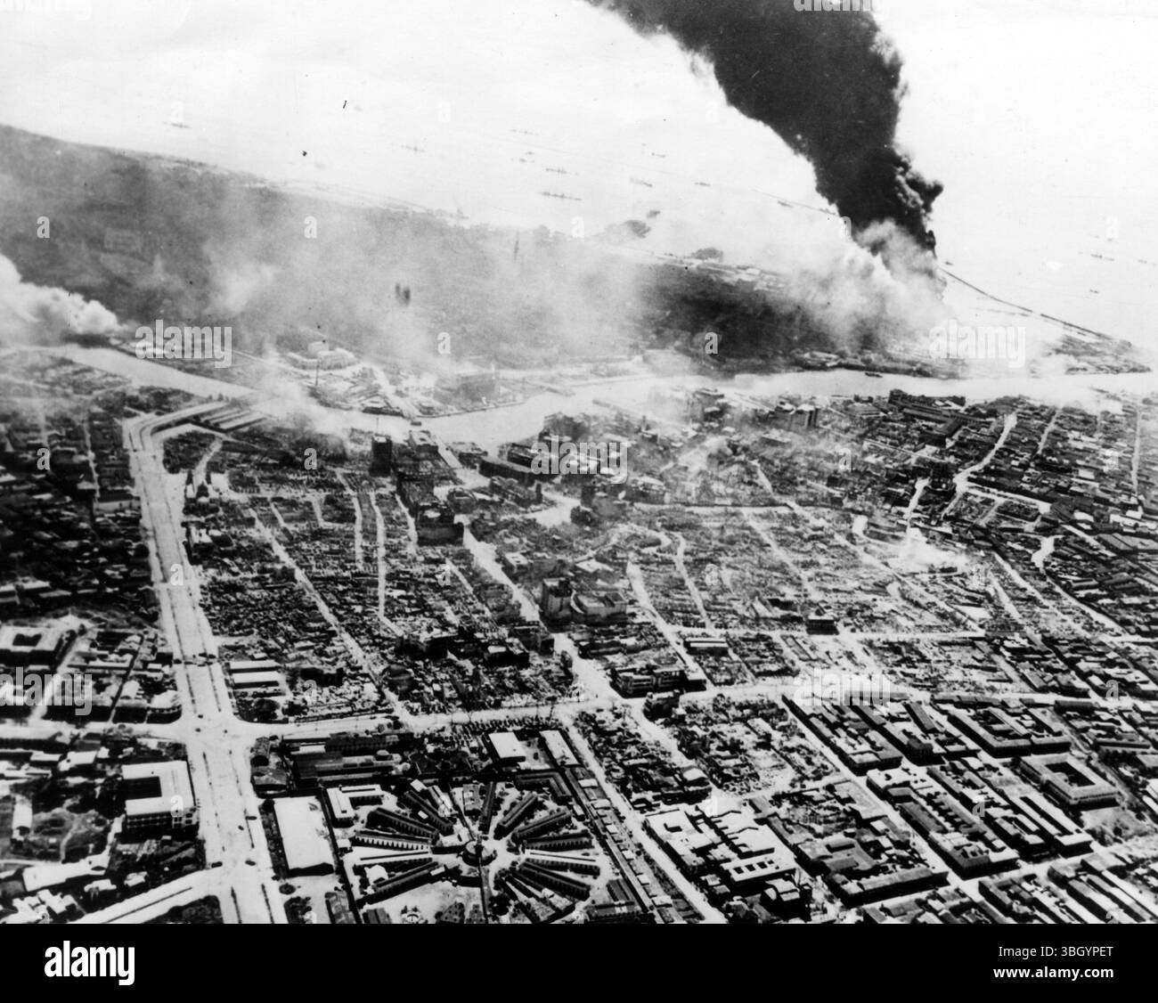 Aerial view of the devastated city of Manila , smoke rising from the ...