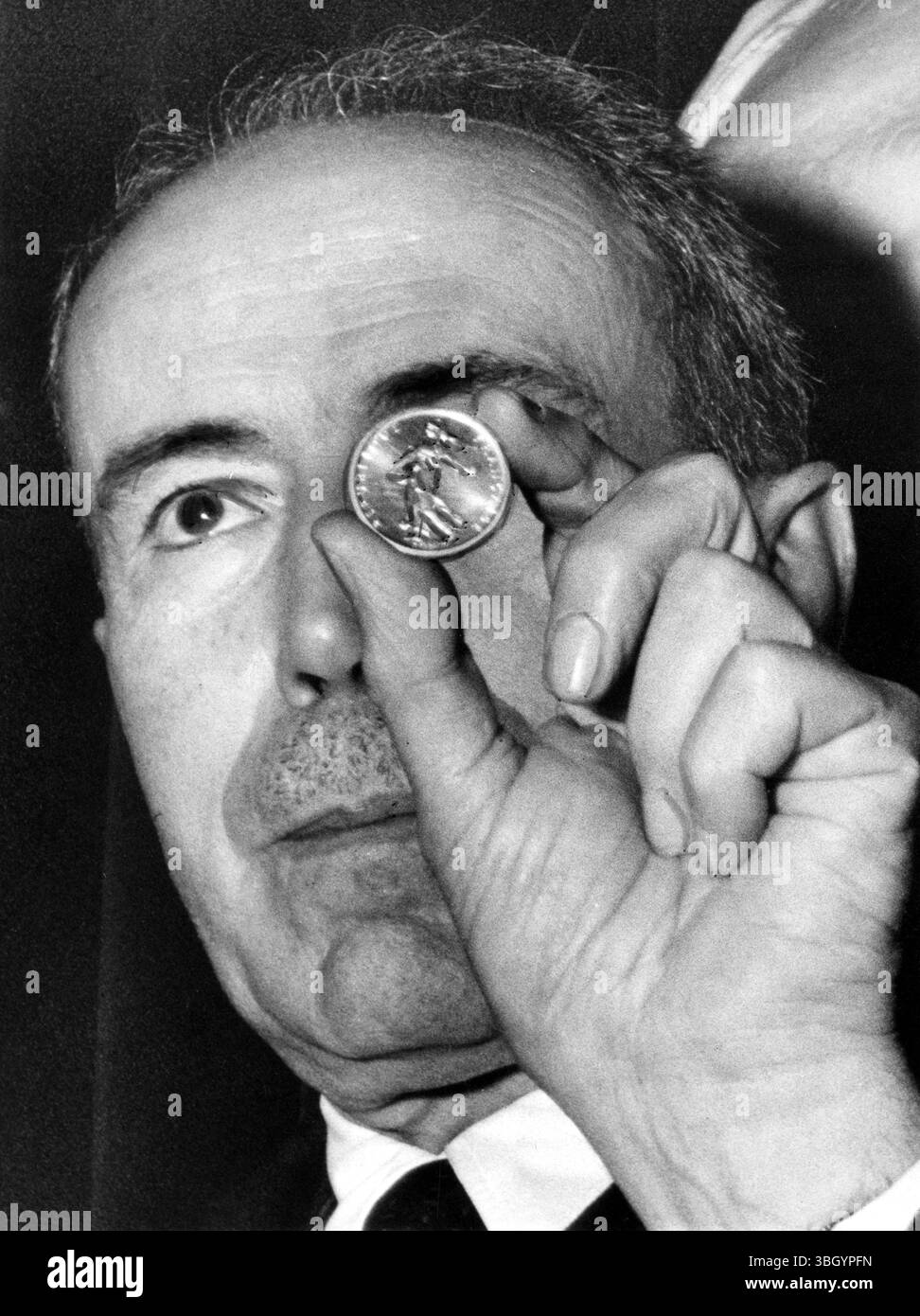 Close up of man holding French coin showing the obverse of the new ...