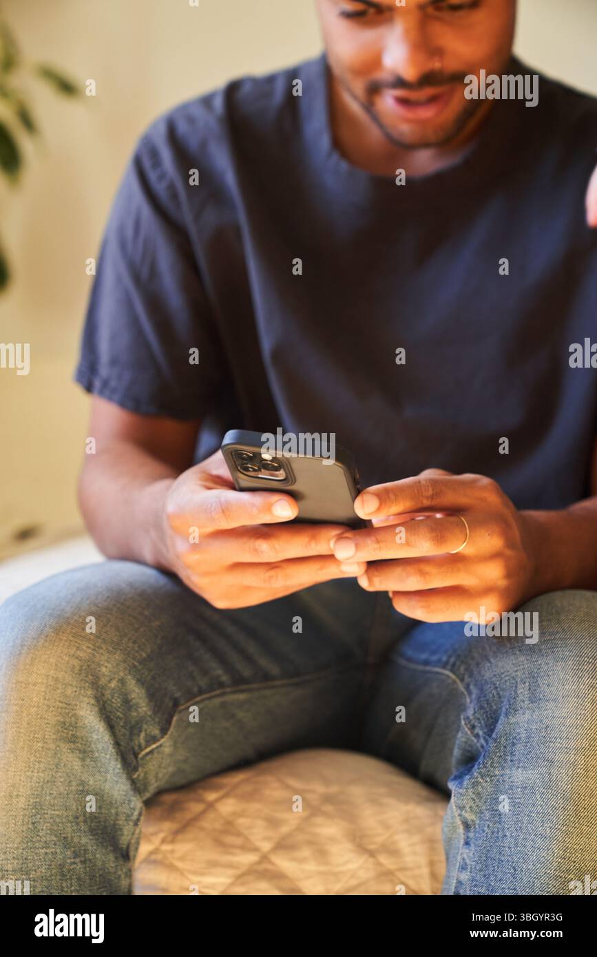 Man looking at his phone Stock Photo - Alamy