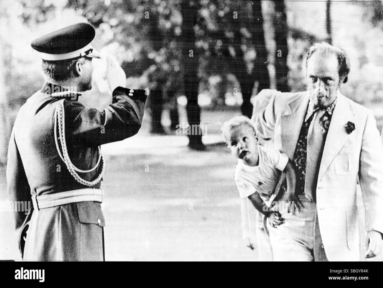 20-month-old Justin Trudeau takes a salute from an RCMP inspector while ...