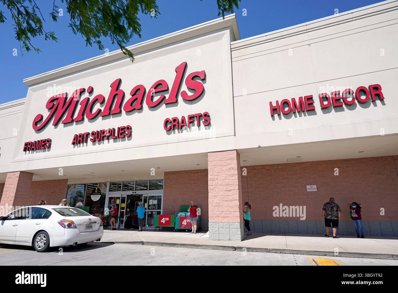 FILE - In this April 24, 2020 file photo, customers lineup outside a ...
