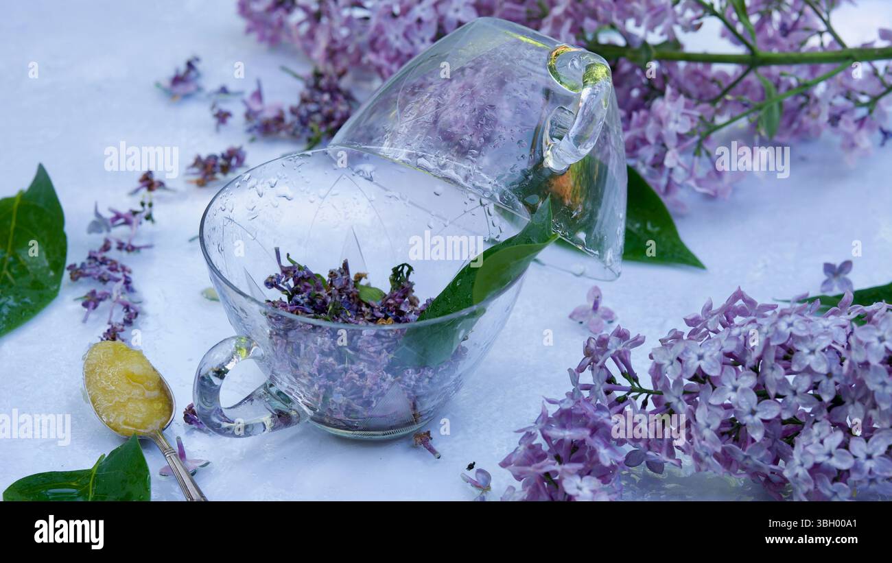 Glass tea cups with lilac around it. A silver spoon with honey. Lilac ...