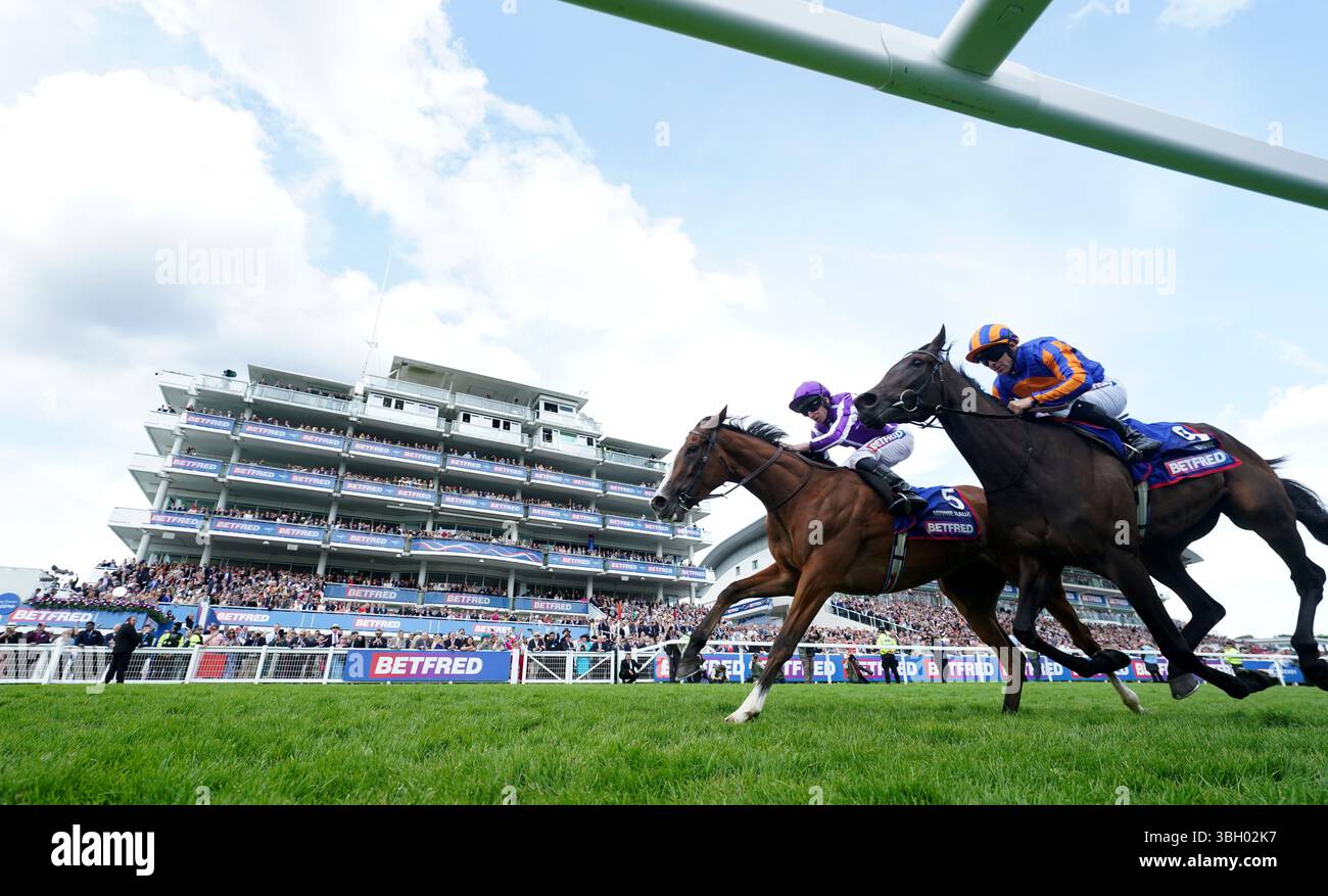 Minnie Hauk ridden by Ryan Moore (left) passes Whirl ridden by Wayne ...
