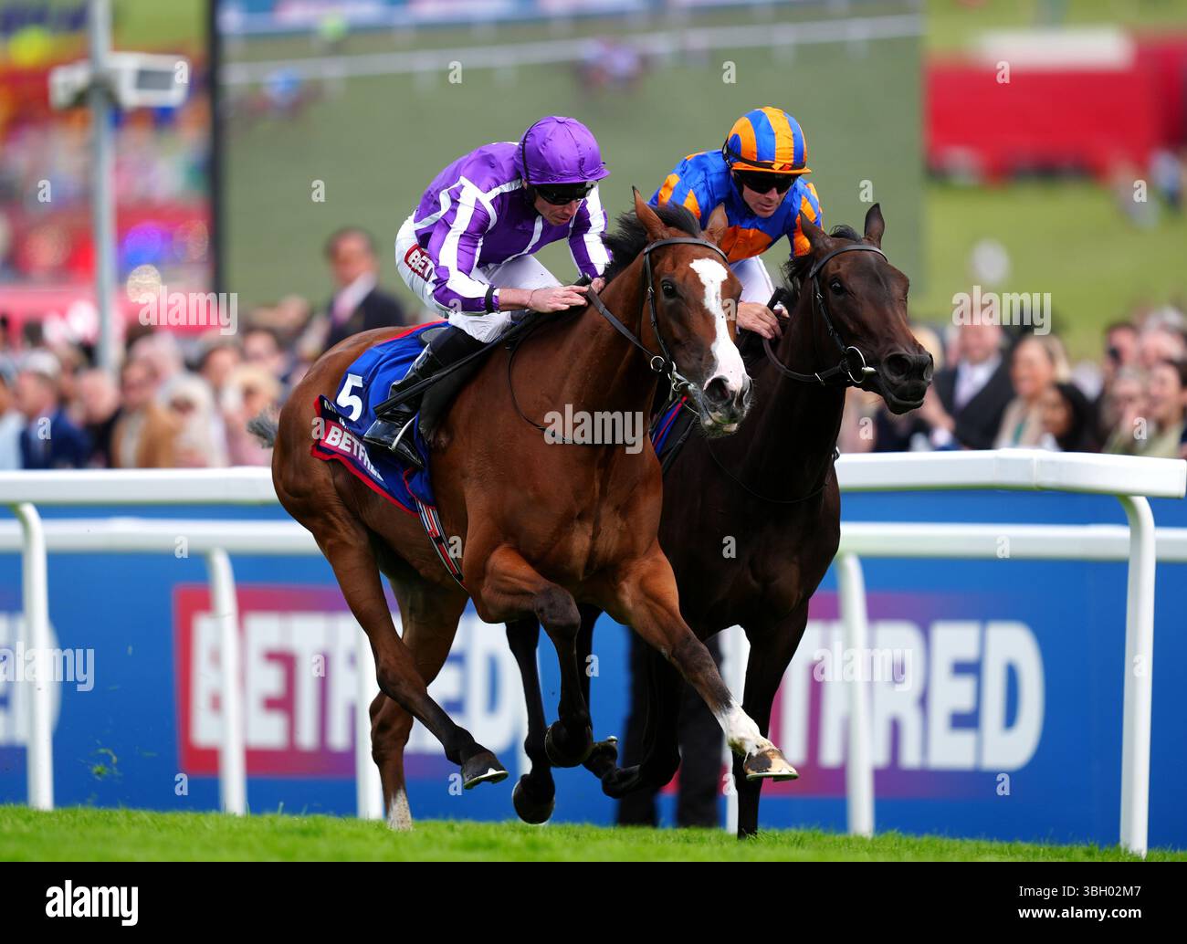 Minnie Hauk ridden by Ryan Moore (left) passes Whirl ridden by Wayne ...