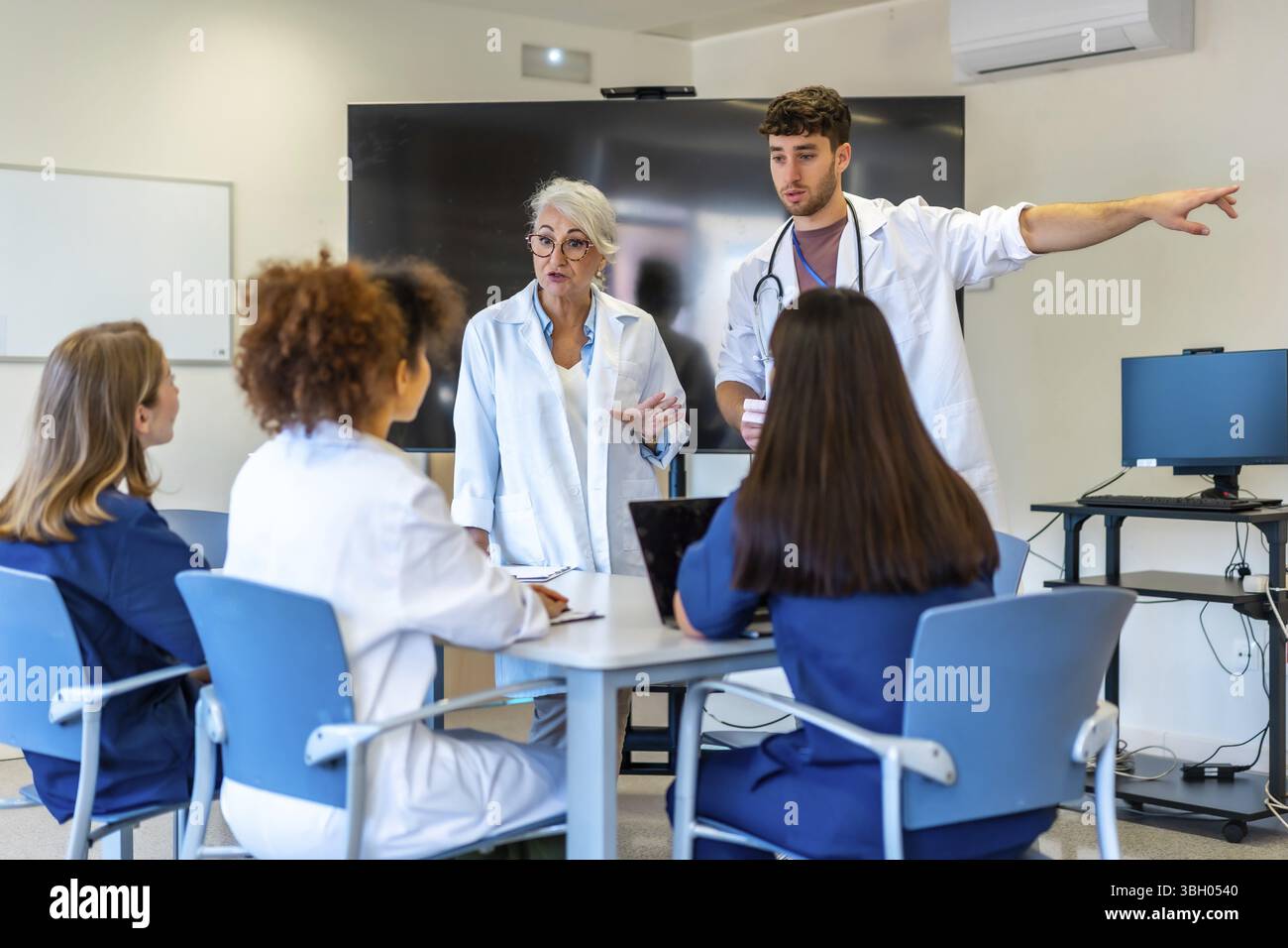 Doctors and nurses having a meeting in a hospital conference room ...