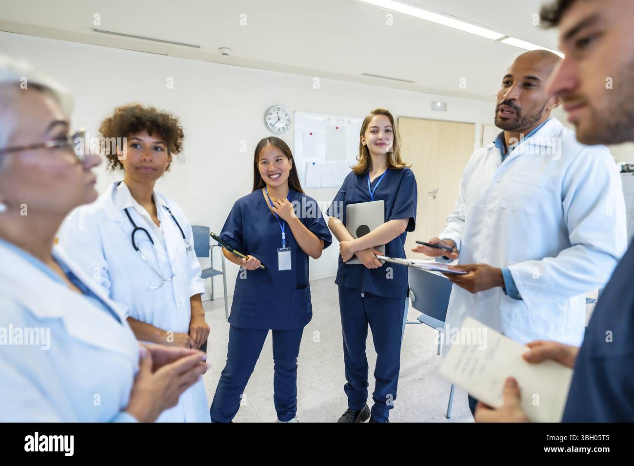 Doctors and nurses engaging in a collaborative discussion during a ...