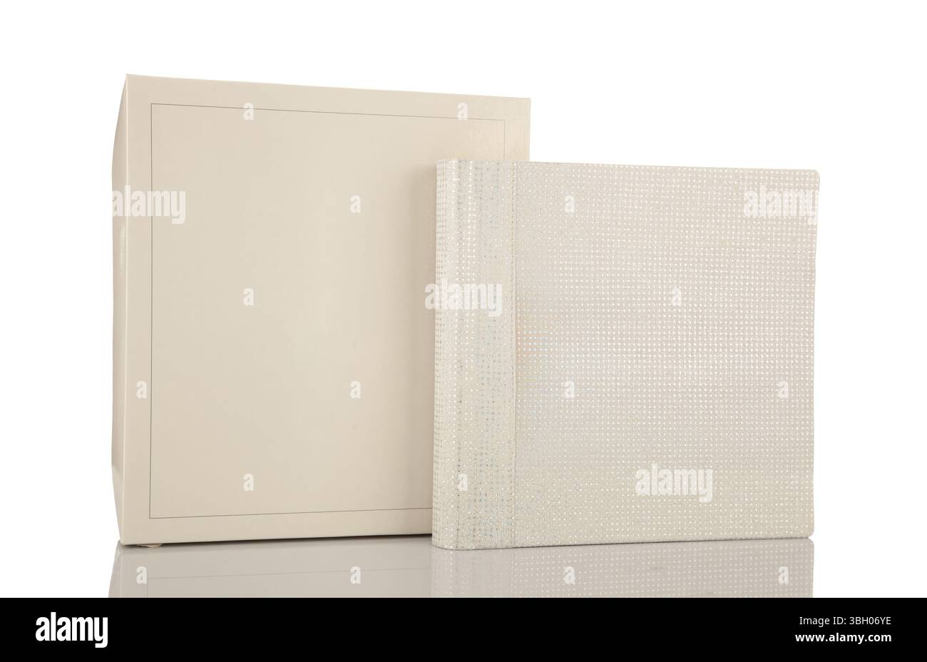 Stylish wedding photo album and its box standing up on a reflective ...