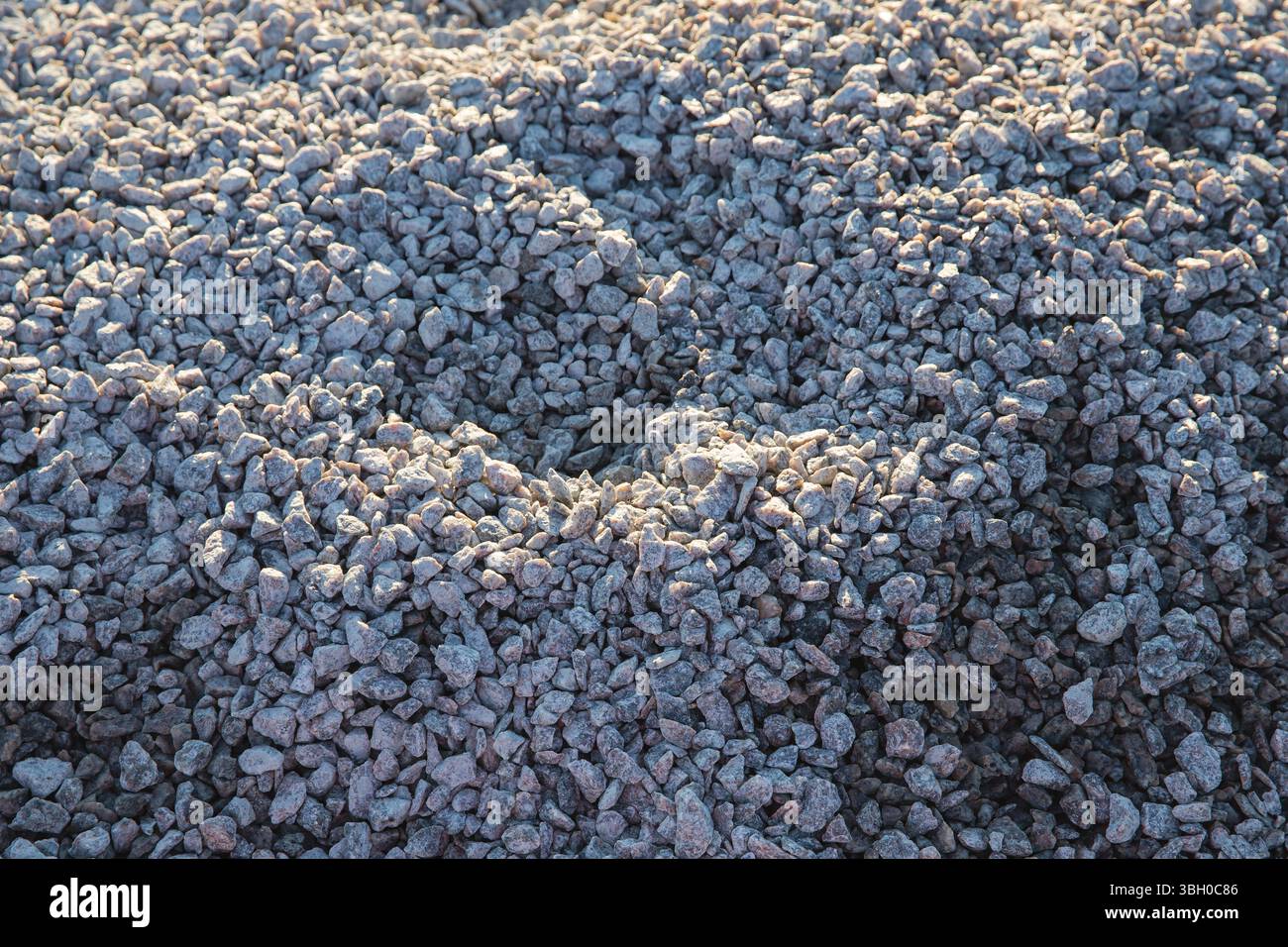Pile of natural crushed stone in daylight. Close-up texture of gray ...