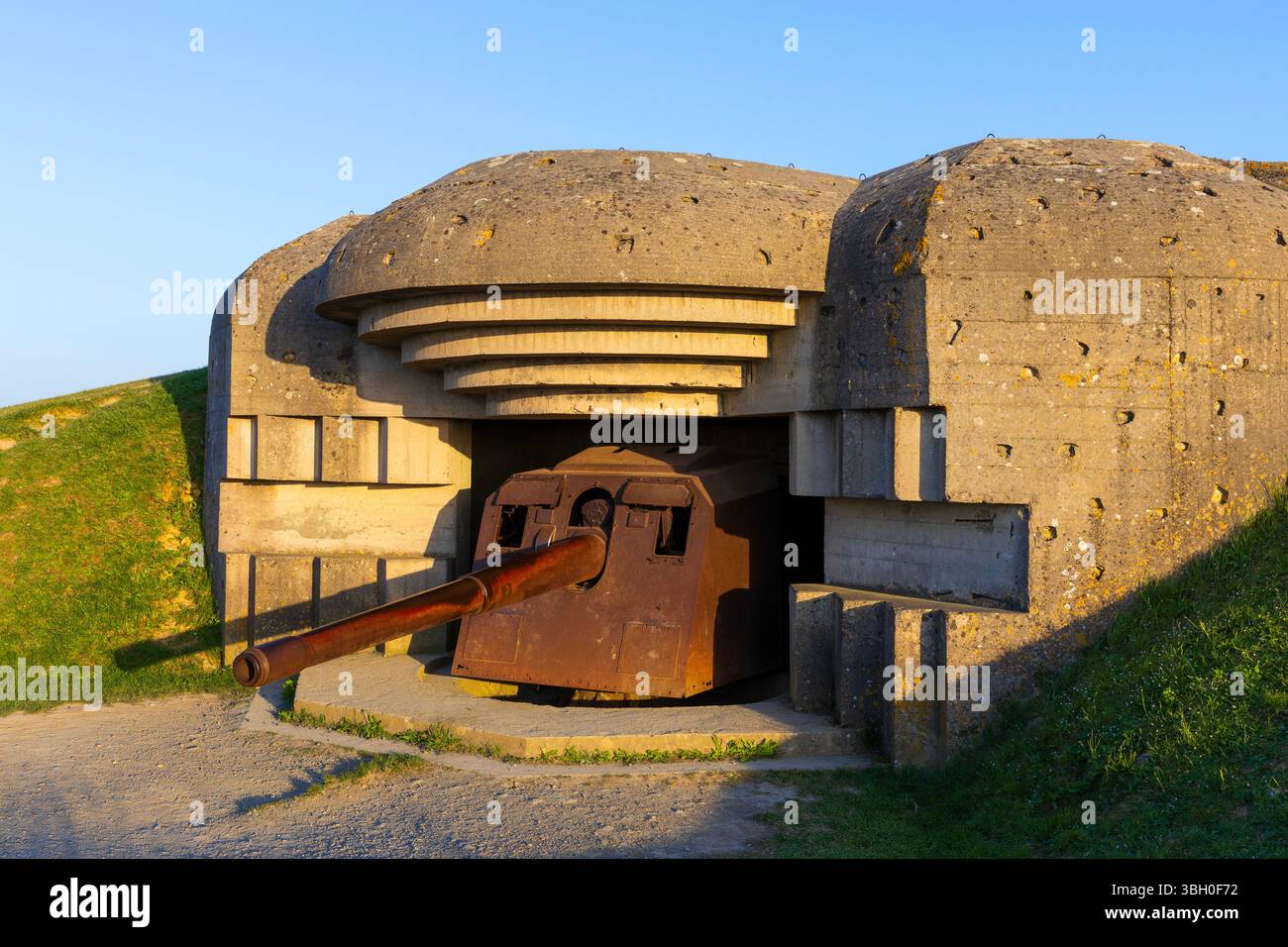 A costal gun of the Longues-sur-Mer battery at sunset, part of Germany ...