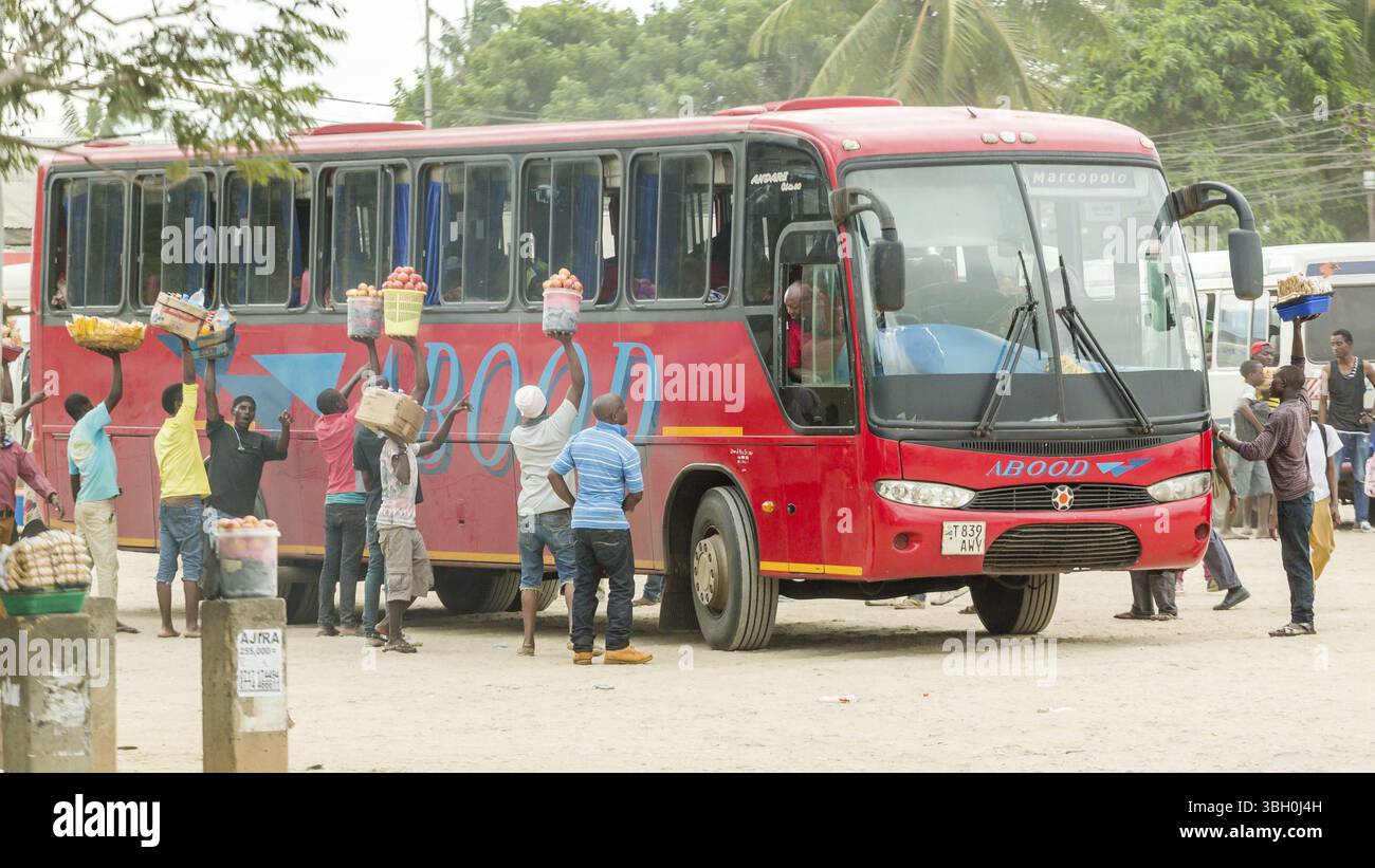 Dar Es Salaam: April 22: Street vendors surround a bus with merchandise ...